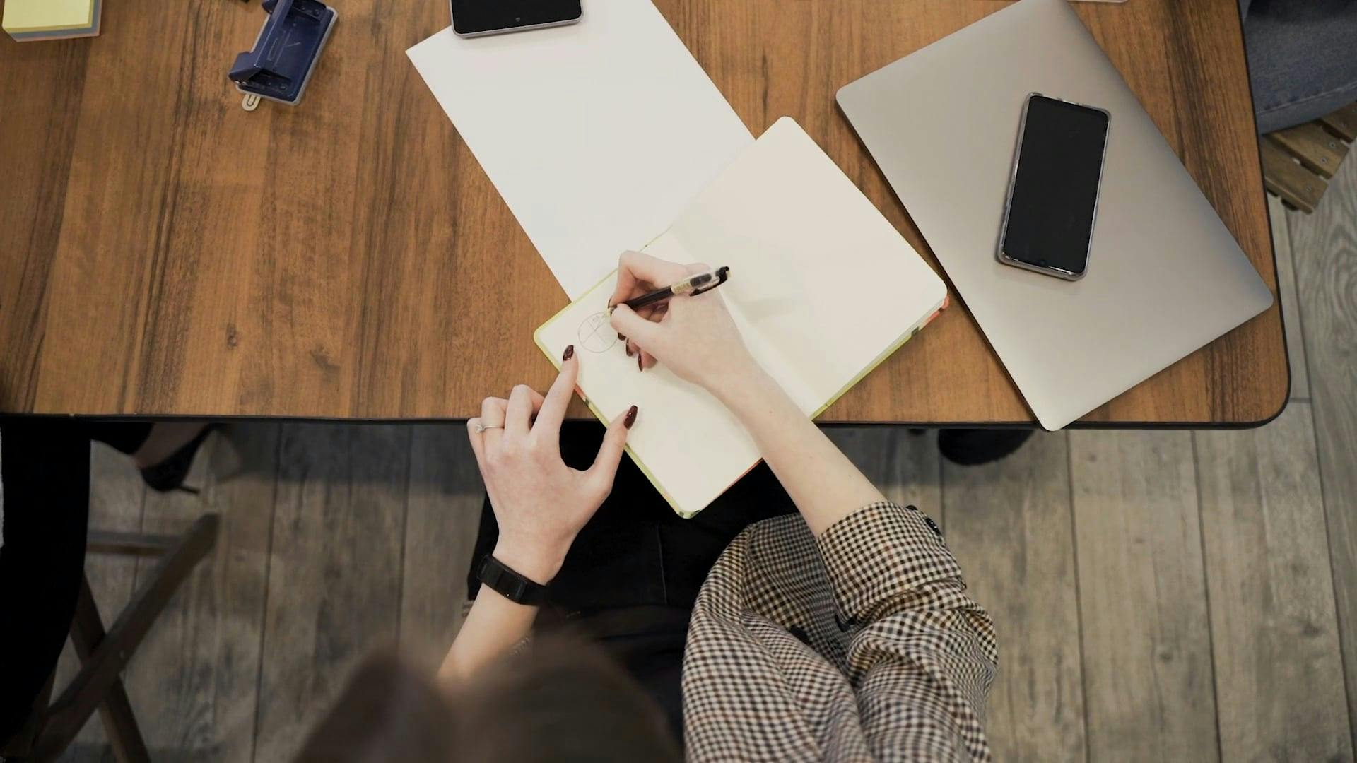 A Person Drawing on a Notepad · Free Stock Video