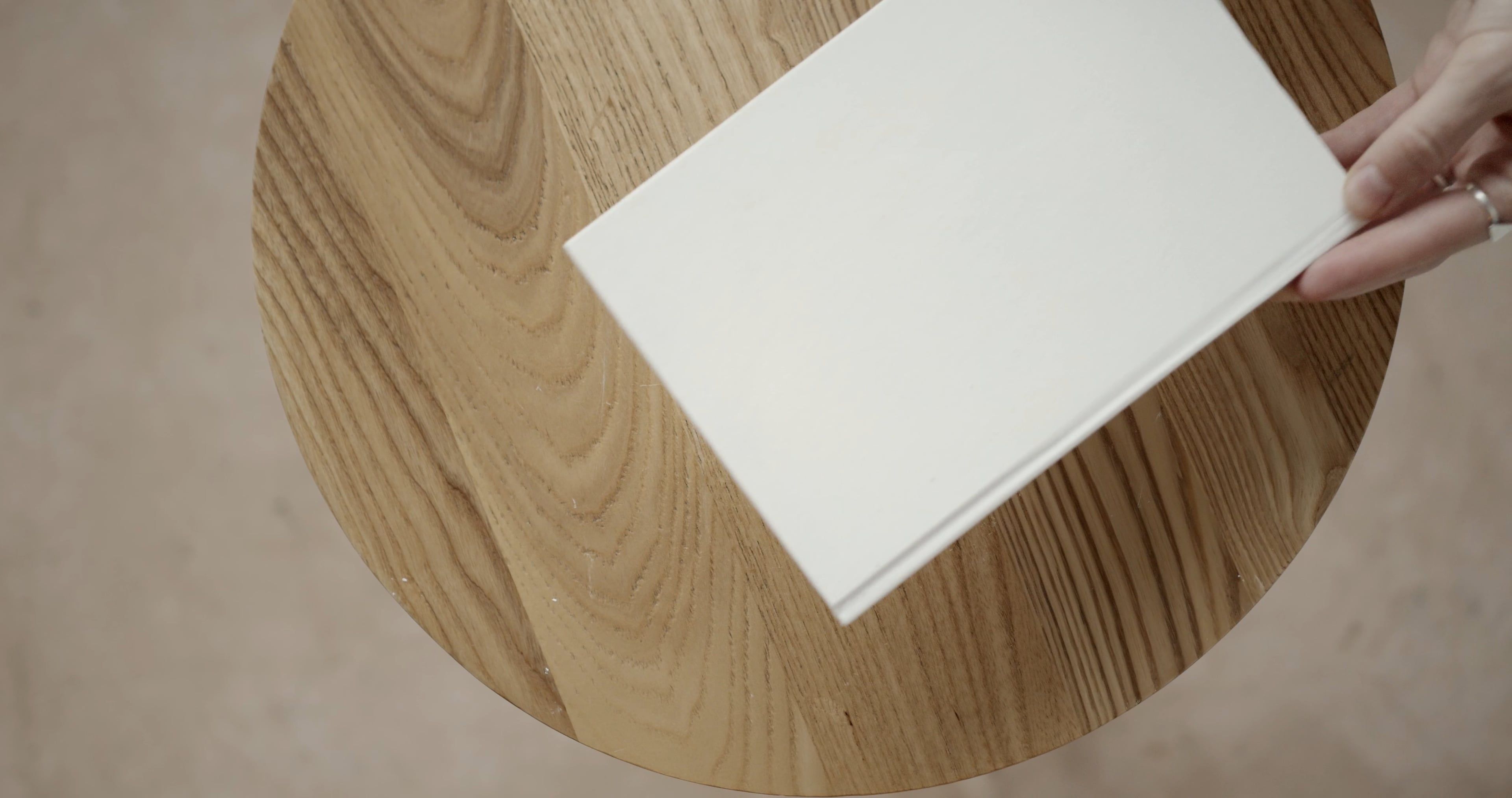 Person Placing White Notebook Over Wooden Surface Free Stock Video ...