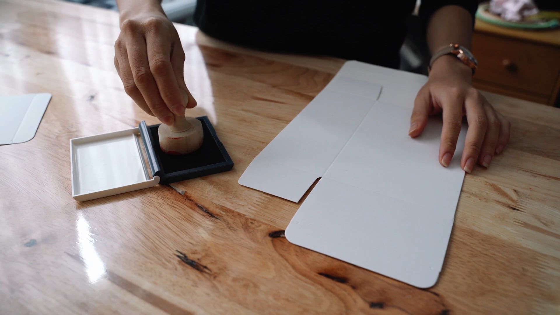 A Person Stamping a Logo on a Packaging · Free Stock Video
