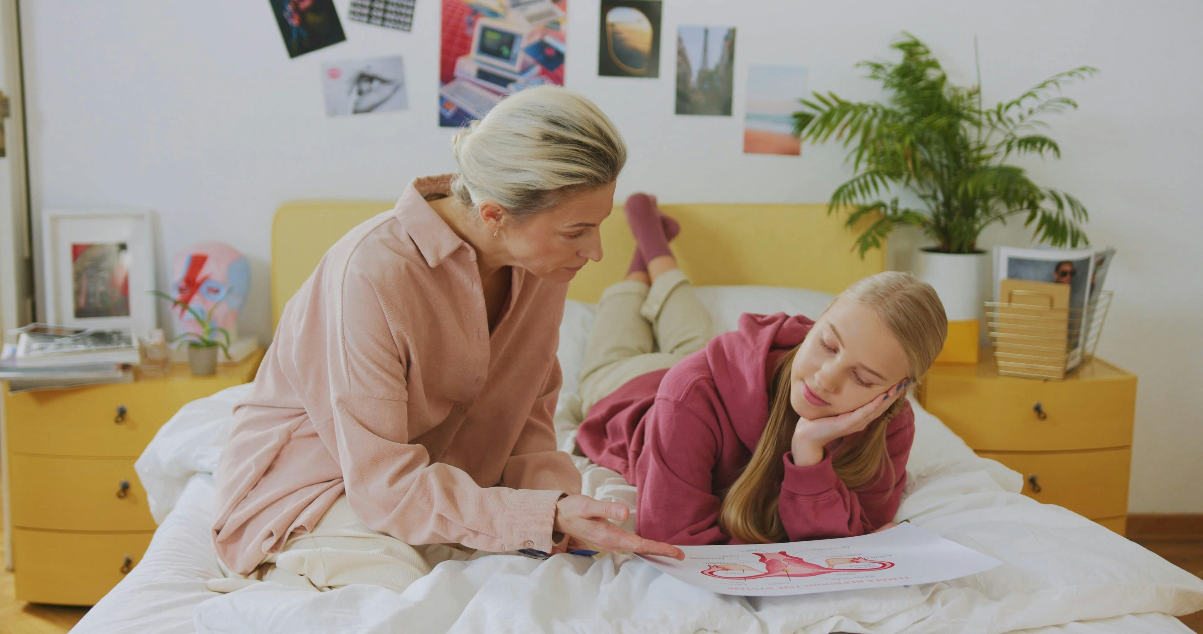 Mother Explaining Female Reproductive System To Her Daughter Free Stock ...