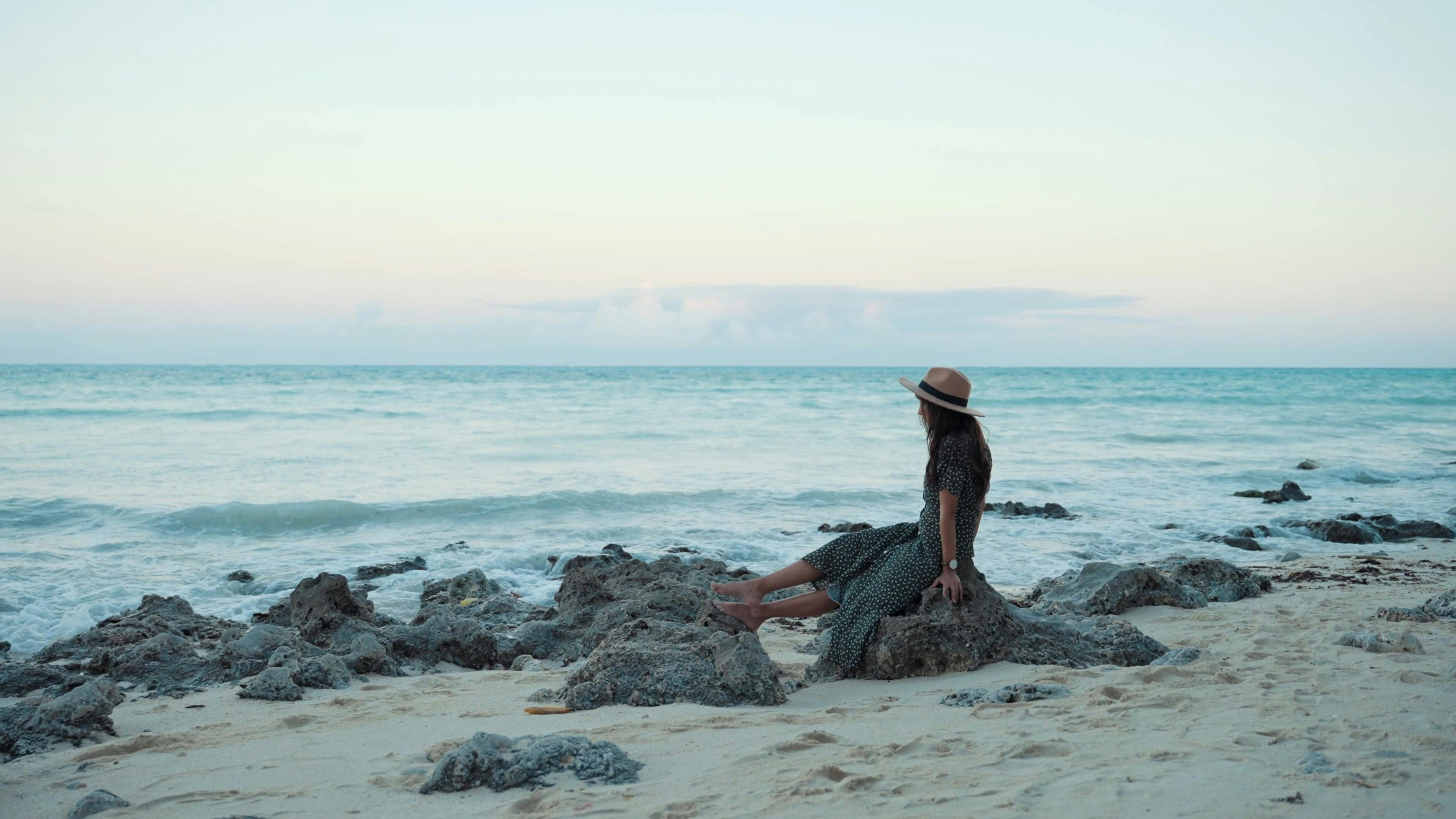 Woman Seated On Rock While Observing Sea Horizon · Free Stock Video