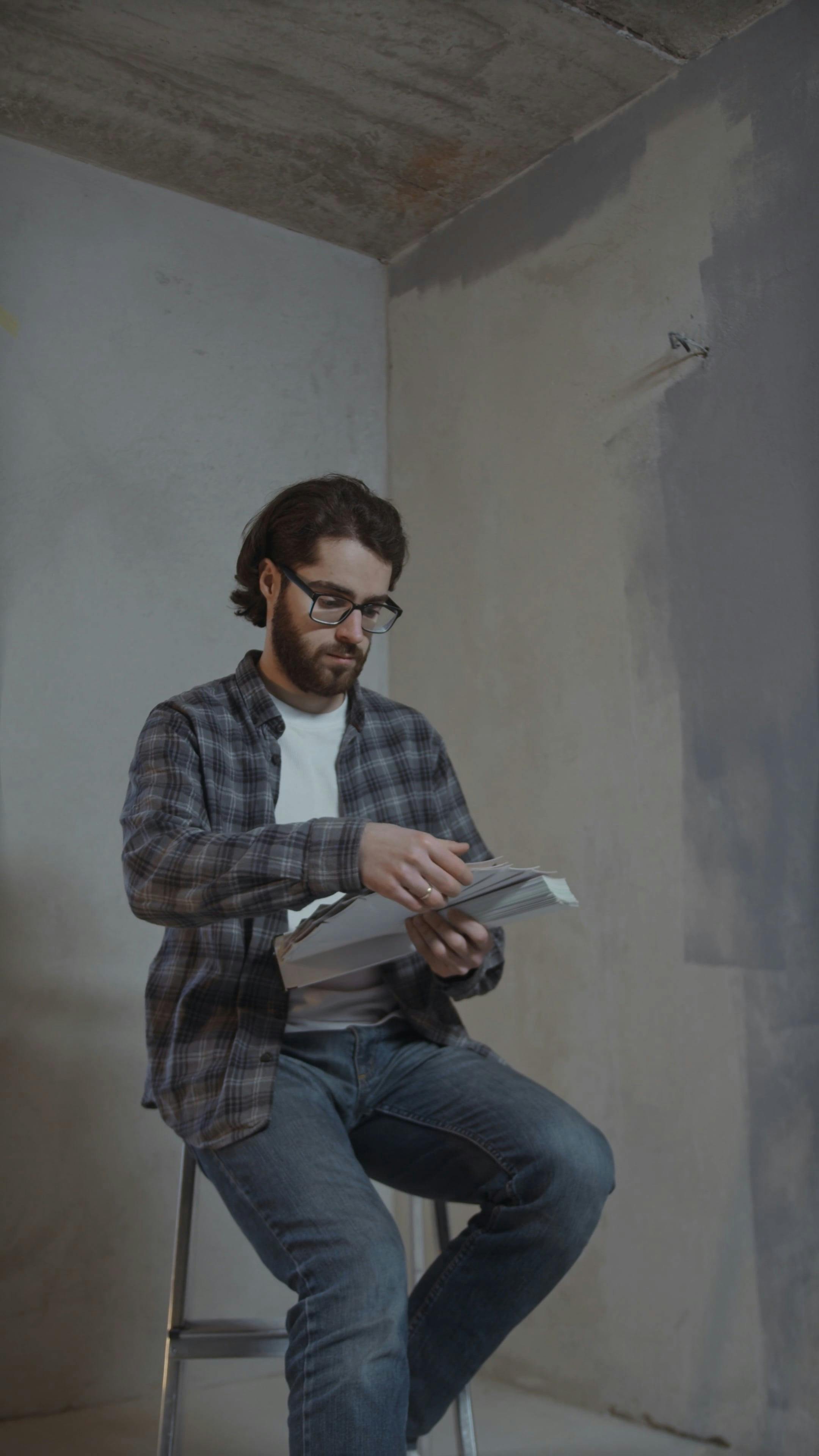 Man Choosing Paint Color from Pantone Cards · Free Stock Video