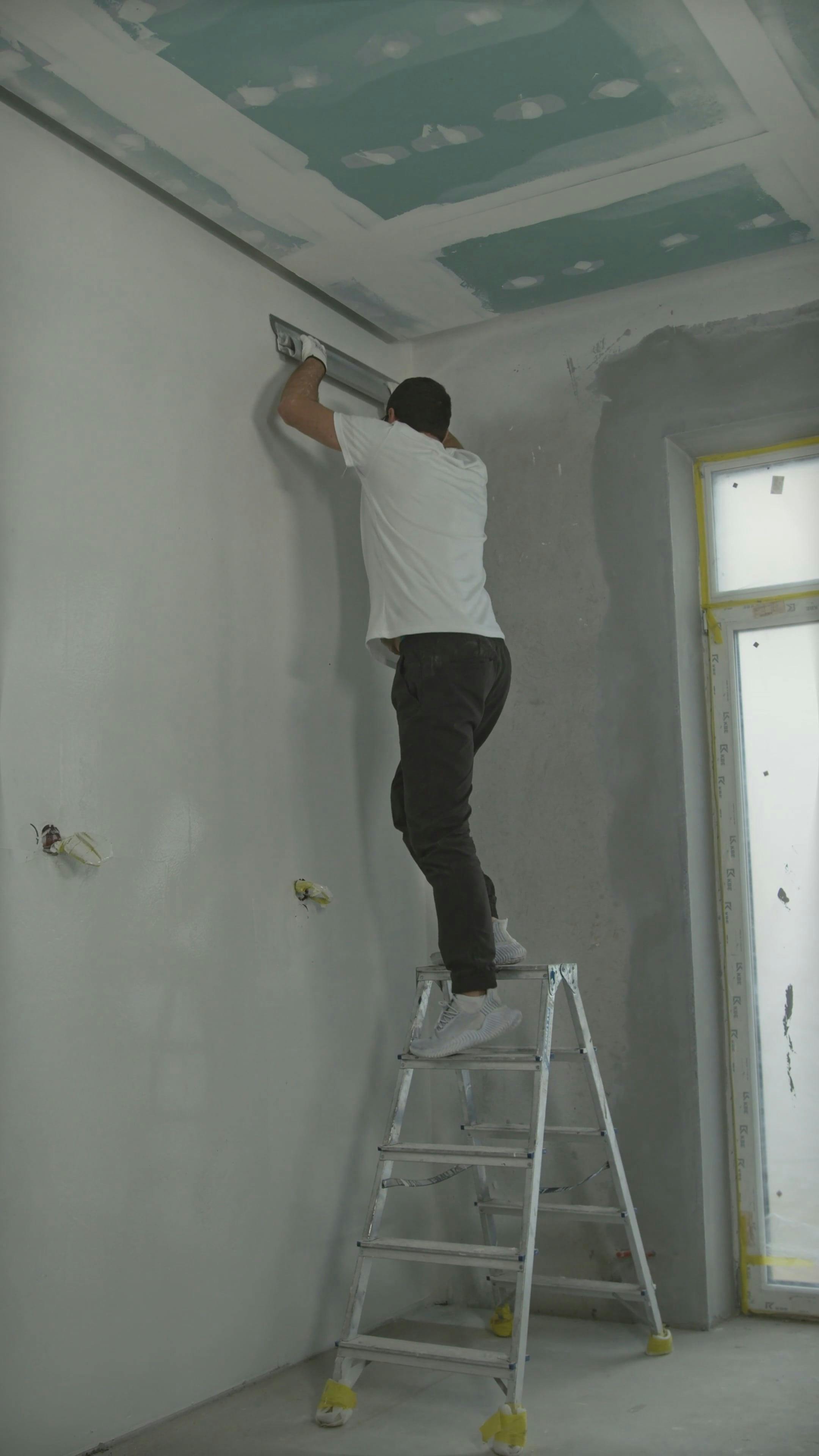 Worker Making Walls Smooth with Putty · Free Stock Video