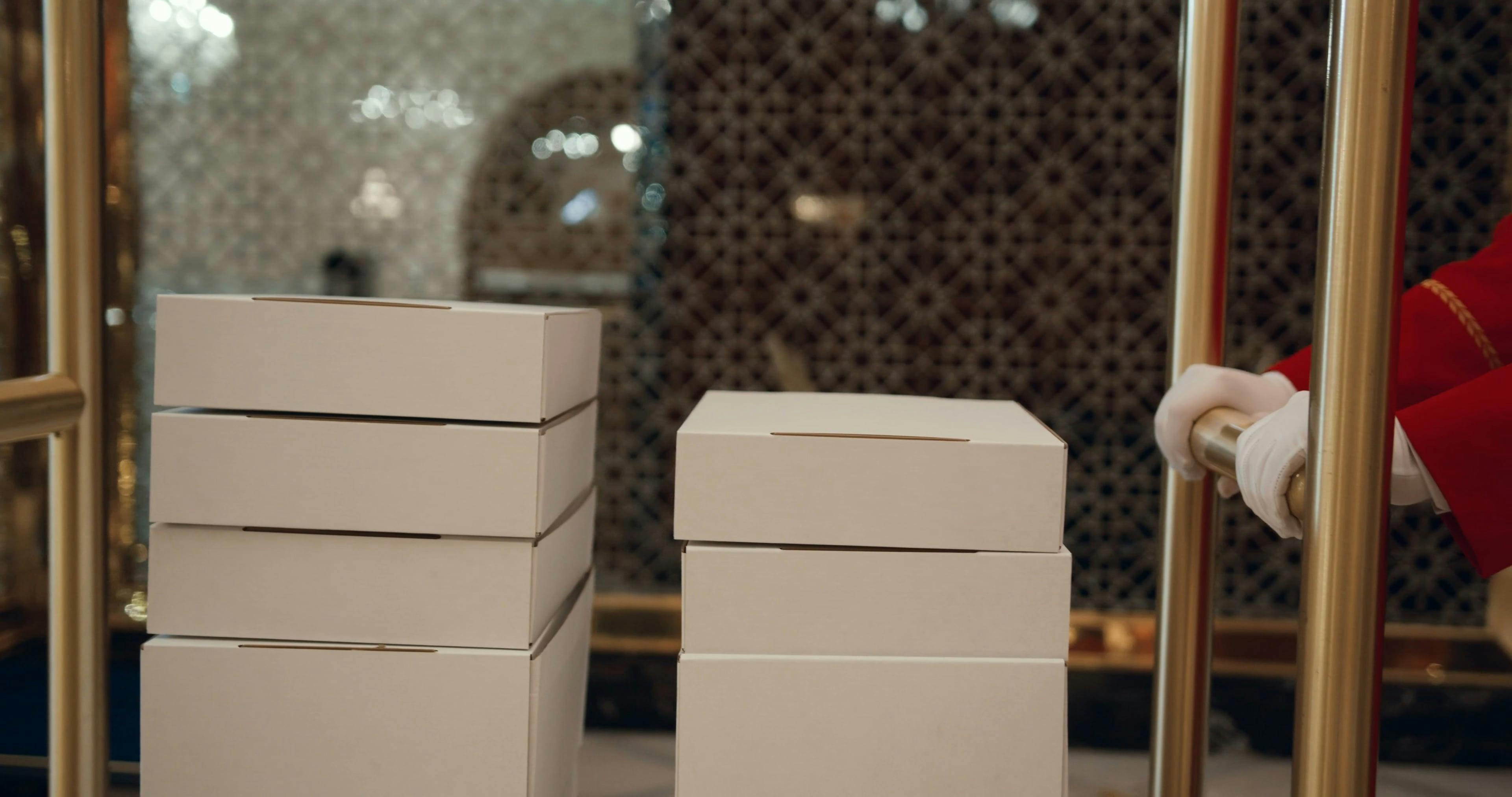 Concierge Pushing Trolley Loaded With White Boxes Free Stock Video ...