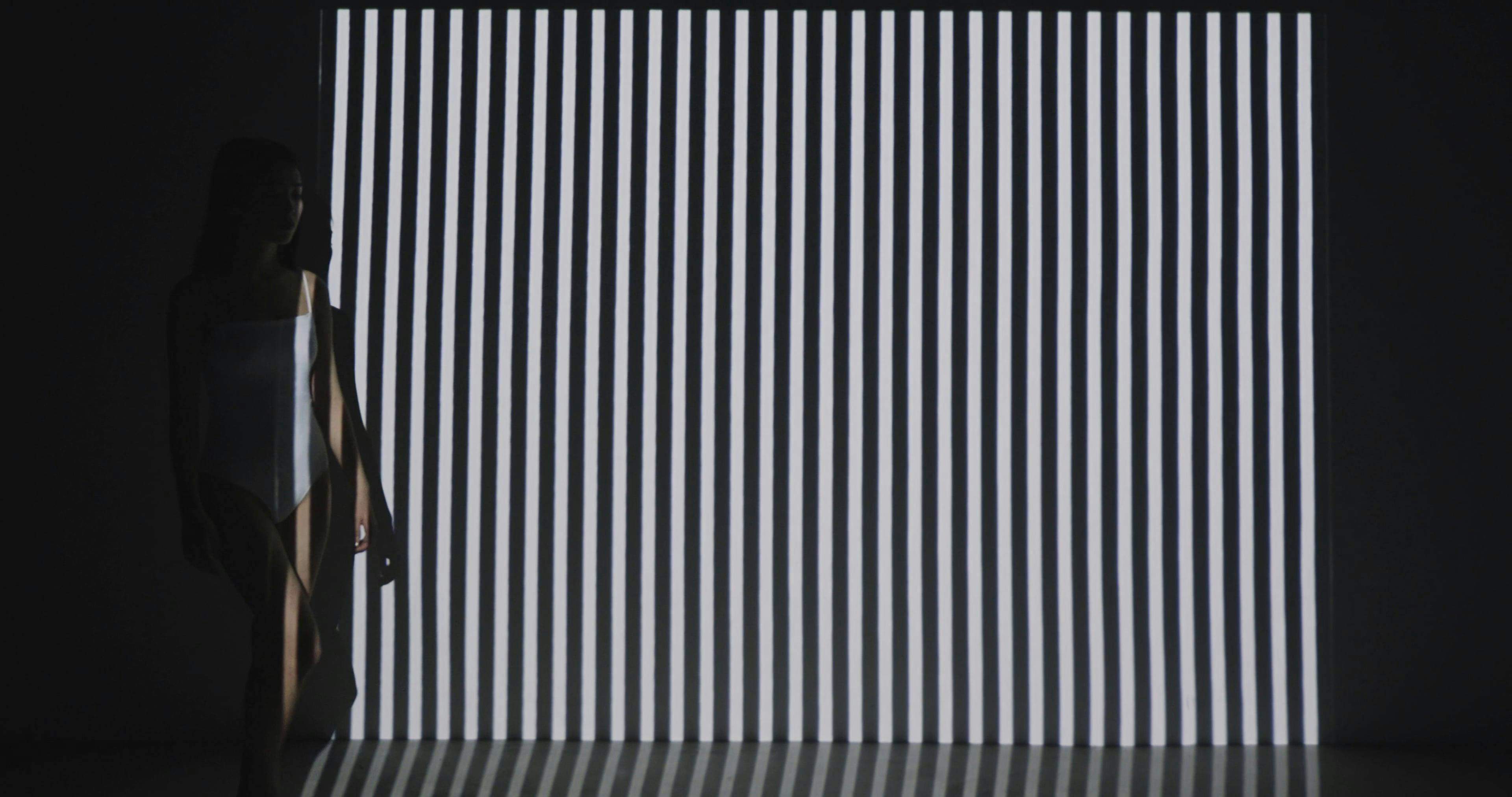 Woman Walking in Striped Shadow · Free Stock Video