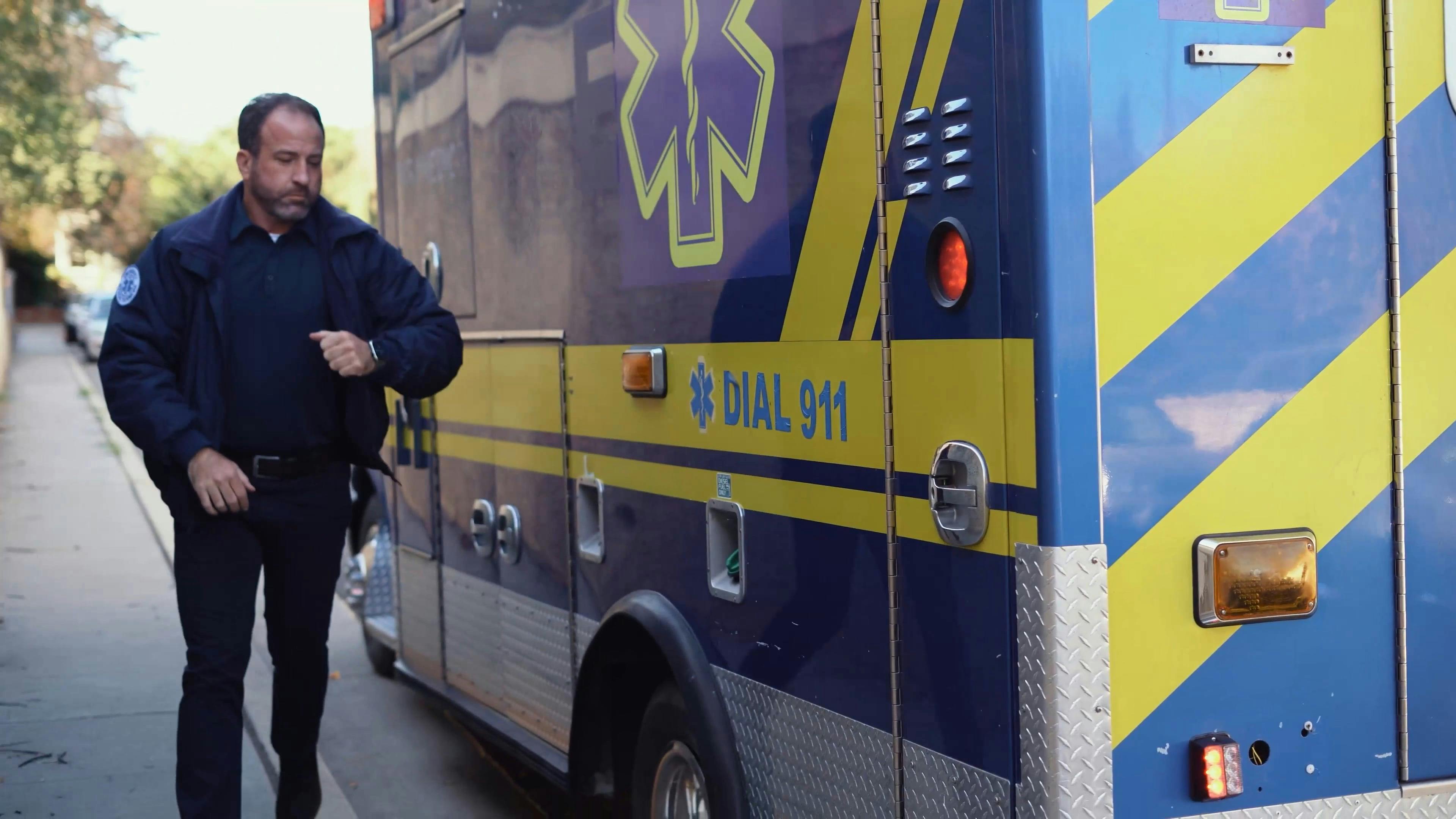 An Ambulance Parked On A Street With Emergency Flashers On Free Stock ...