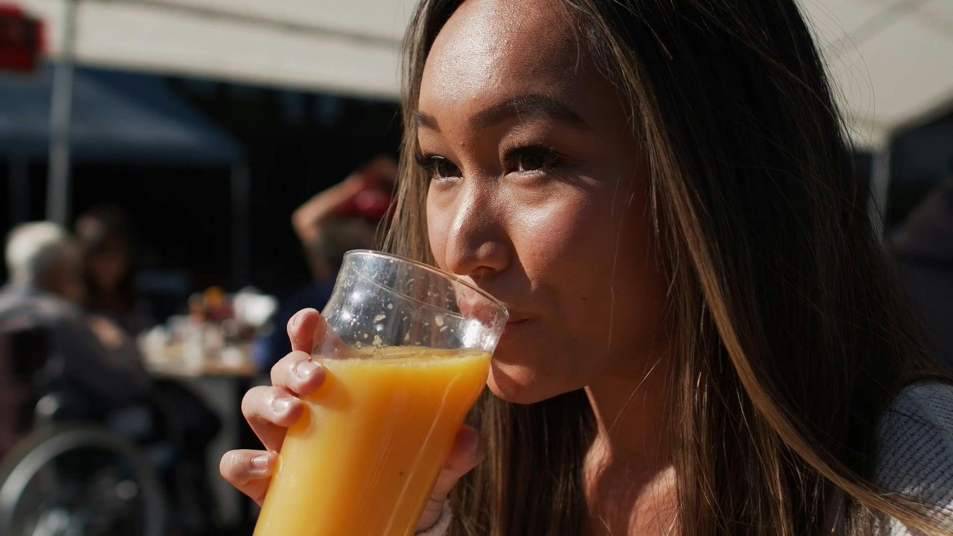 Young Woman Drinking Orange Juice Outdoors Free Stock Video Footage ...