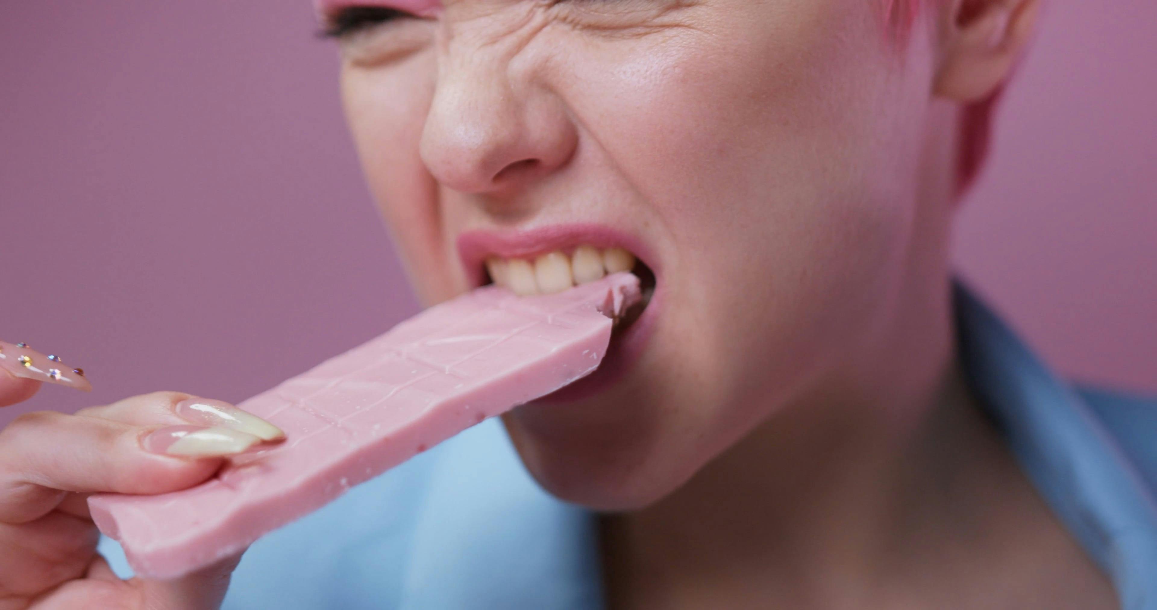 Woman Taking a Bite of Chocolate · Free Stock Video