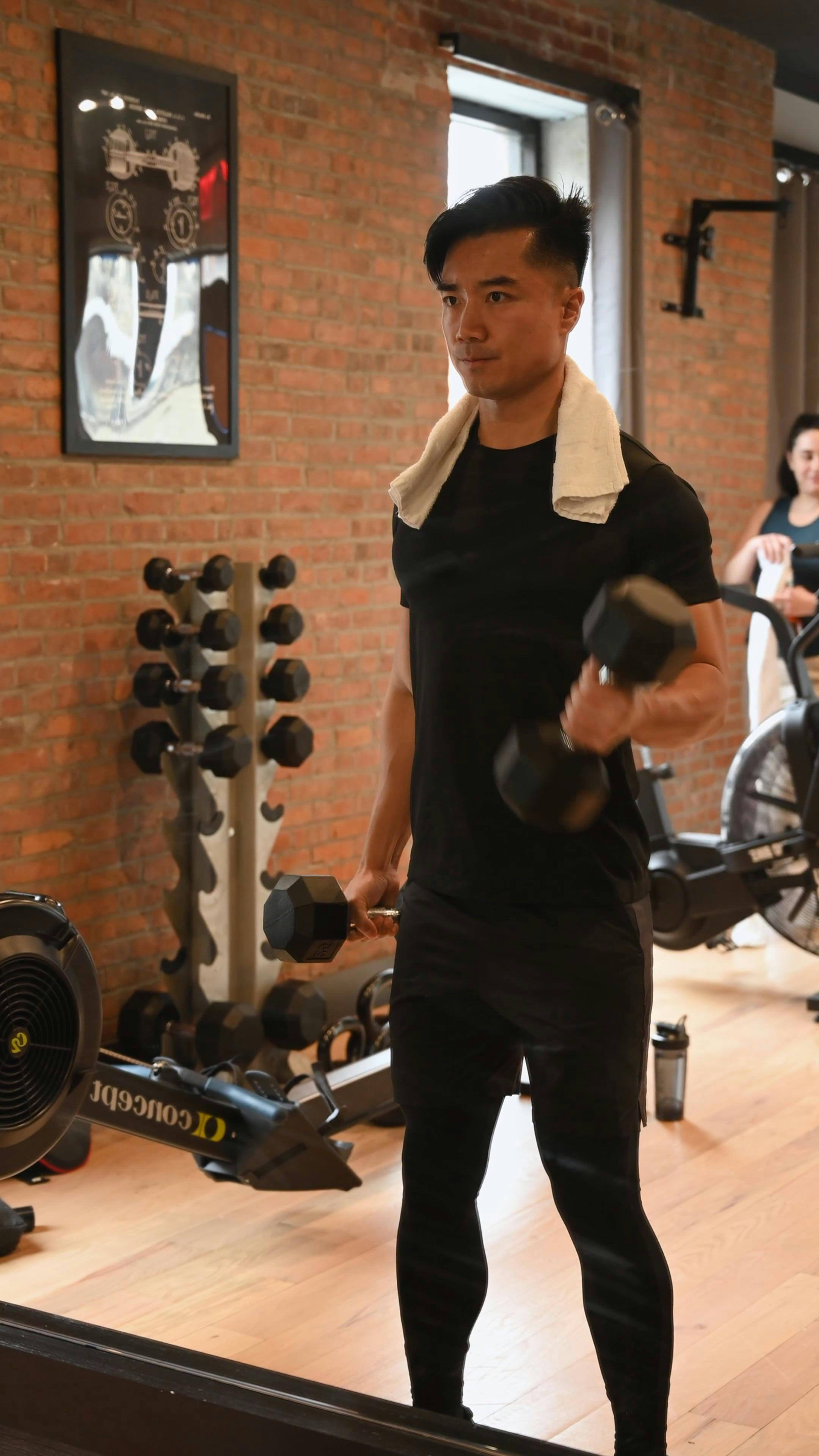 Man Lifting Dumbbells in front of the Mirror · Free Stock Video