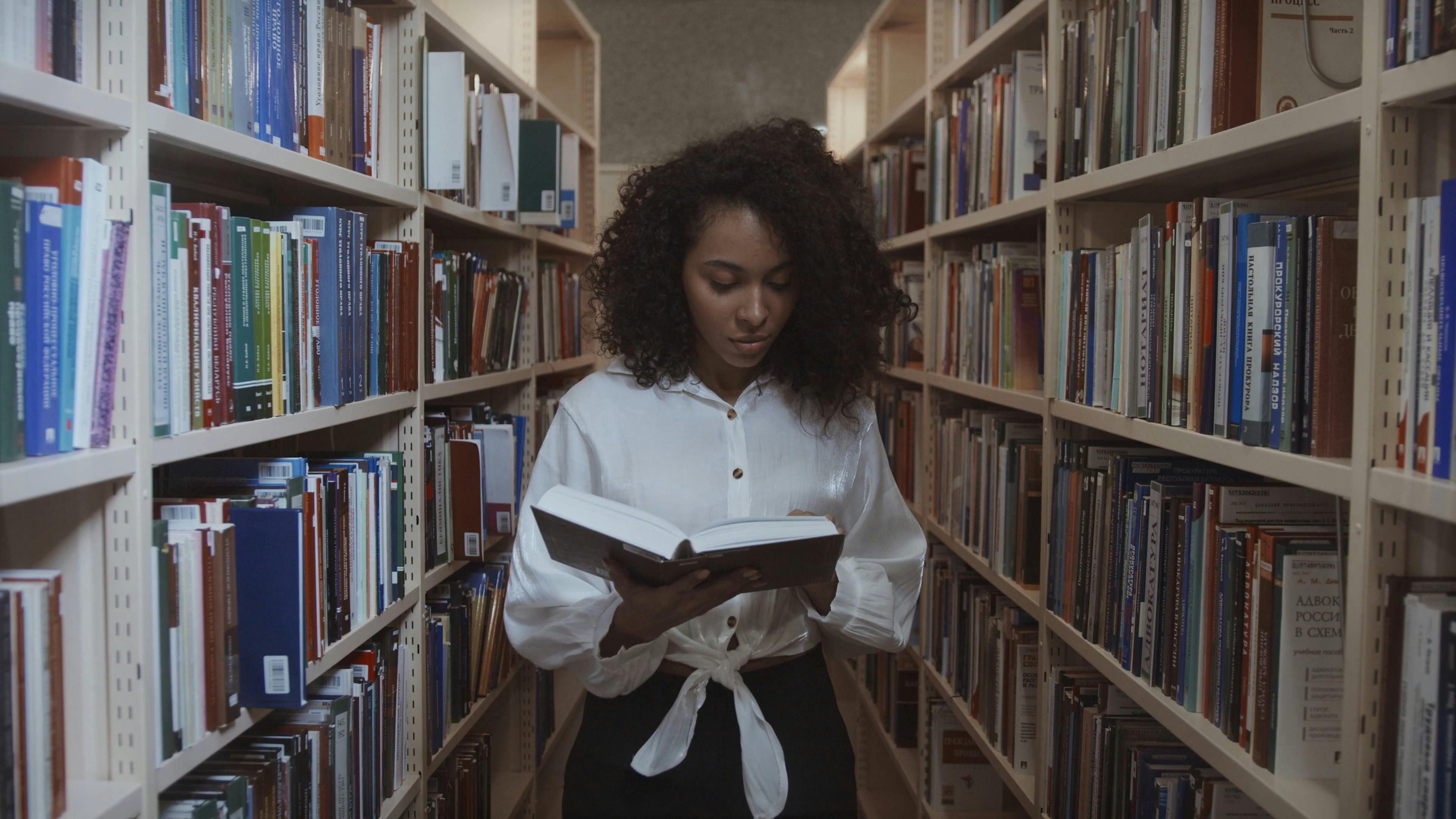 A Woman Reading a Book in a Library Free Stock Video Footage, Royalty ...