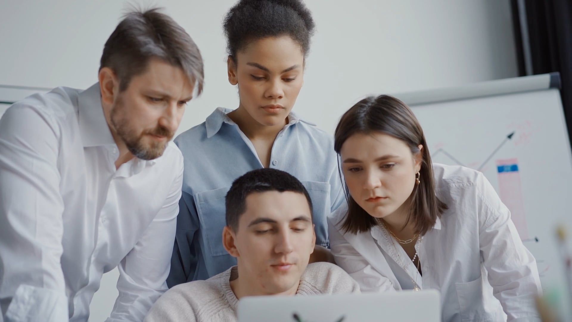 A Group of People Looking at a Laptop · Free Stock Video