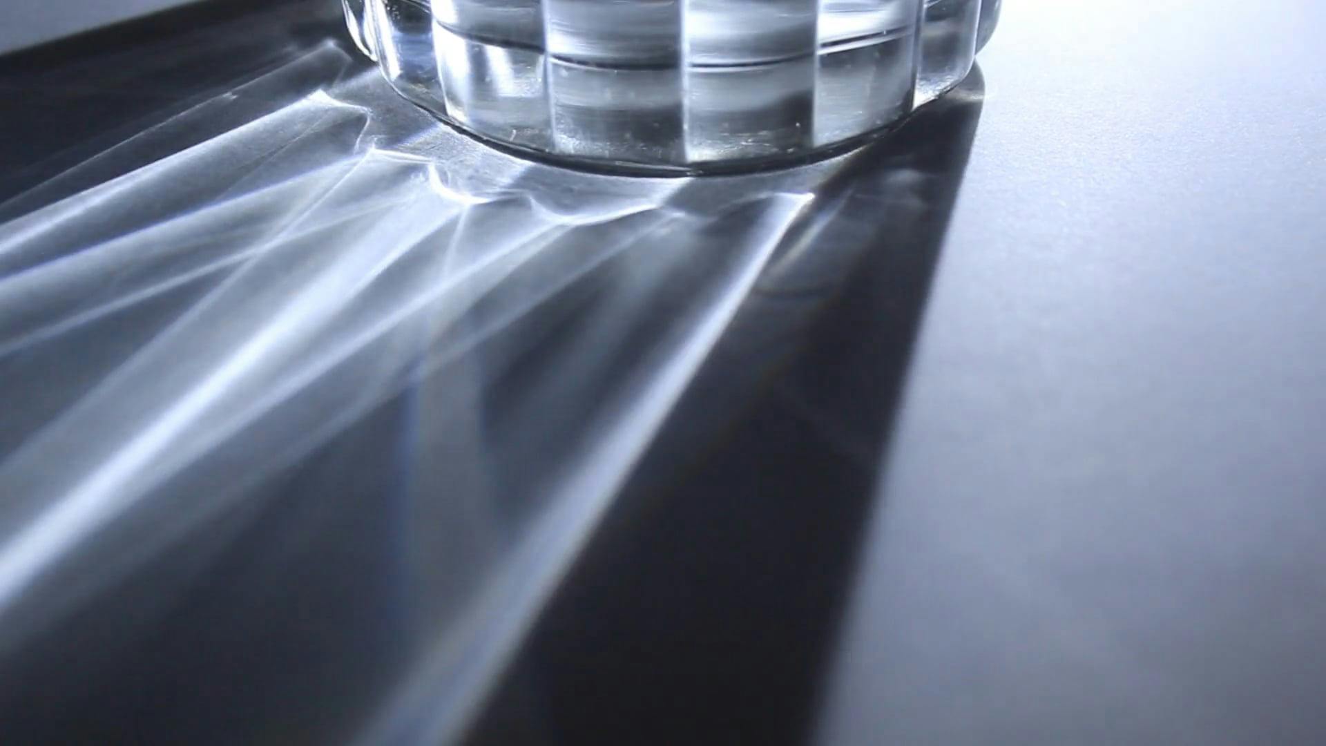 Light Reflections Through Glass of Water · Free Stock Video