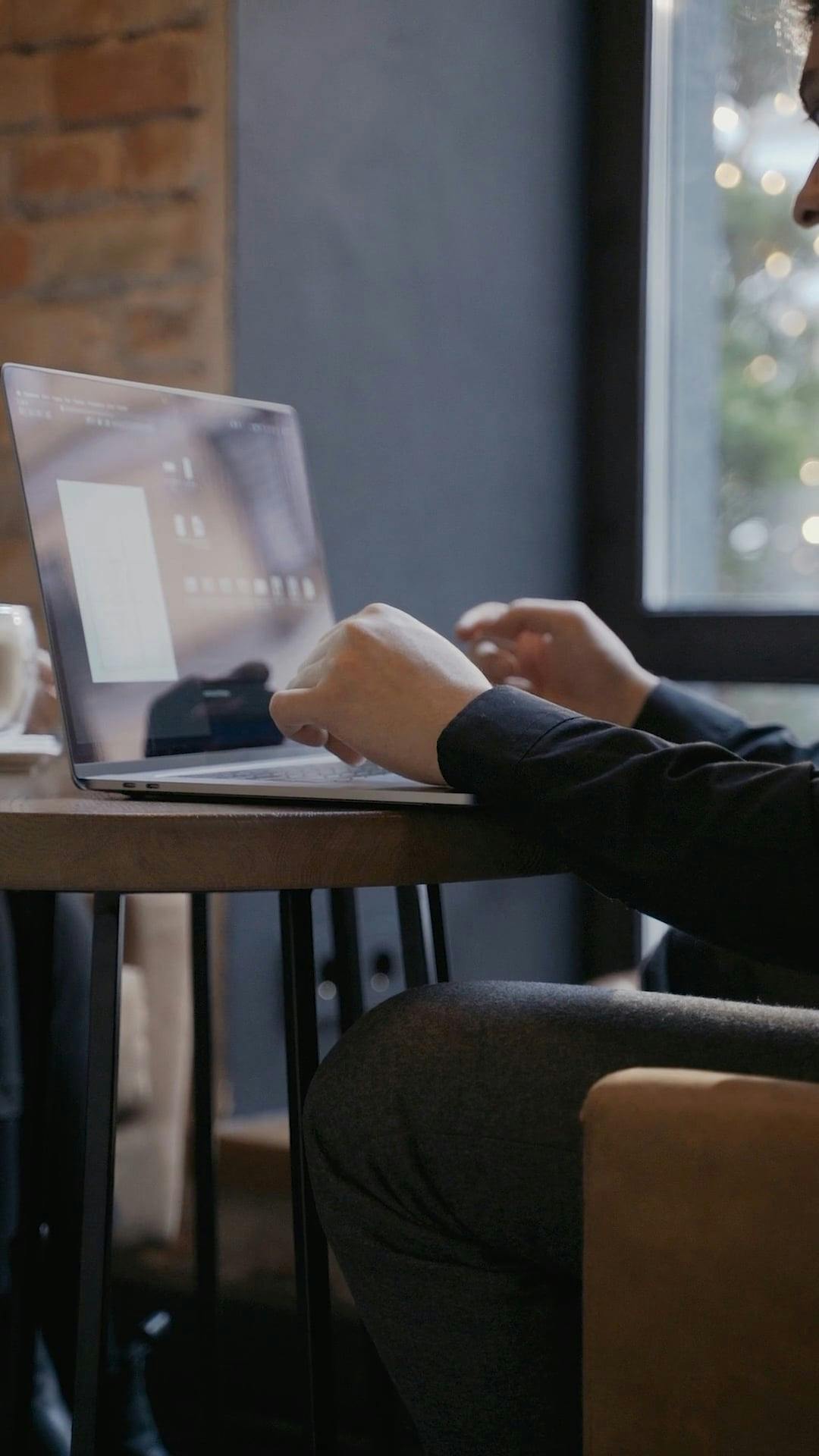 Person Using a Laptop at a Coffee Shop · Free Stock Video