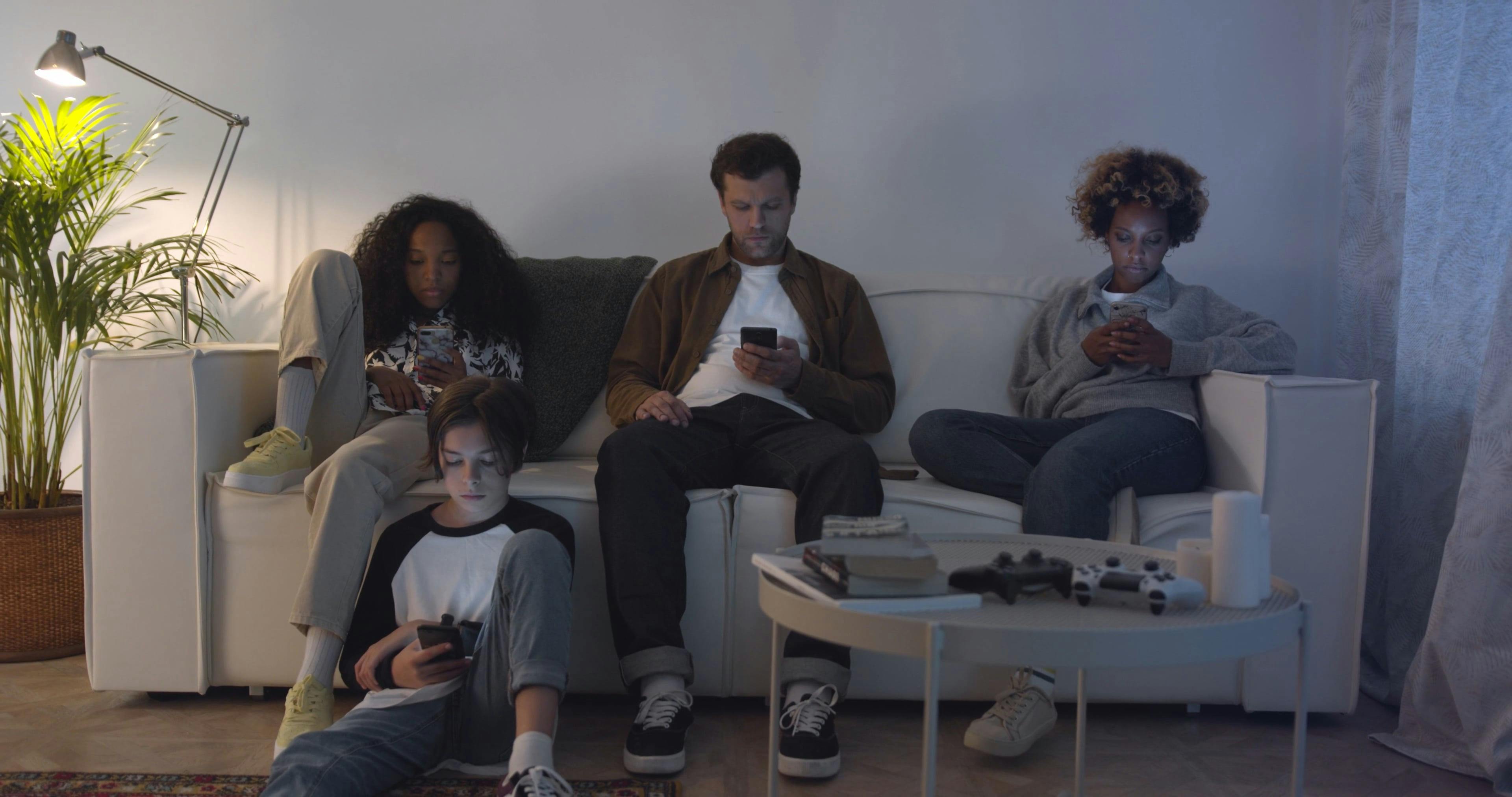 Family in the Living Room Using their Phone · Free Stock Video