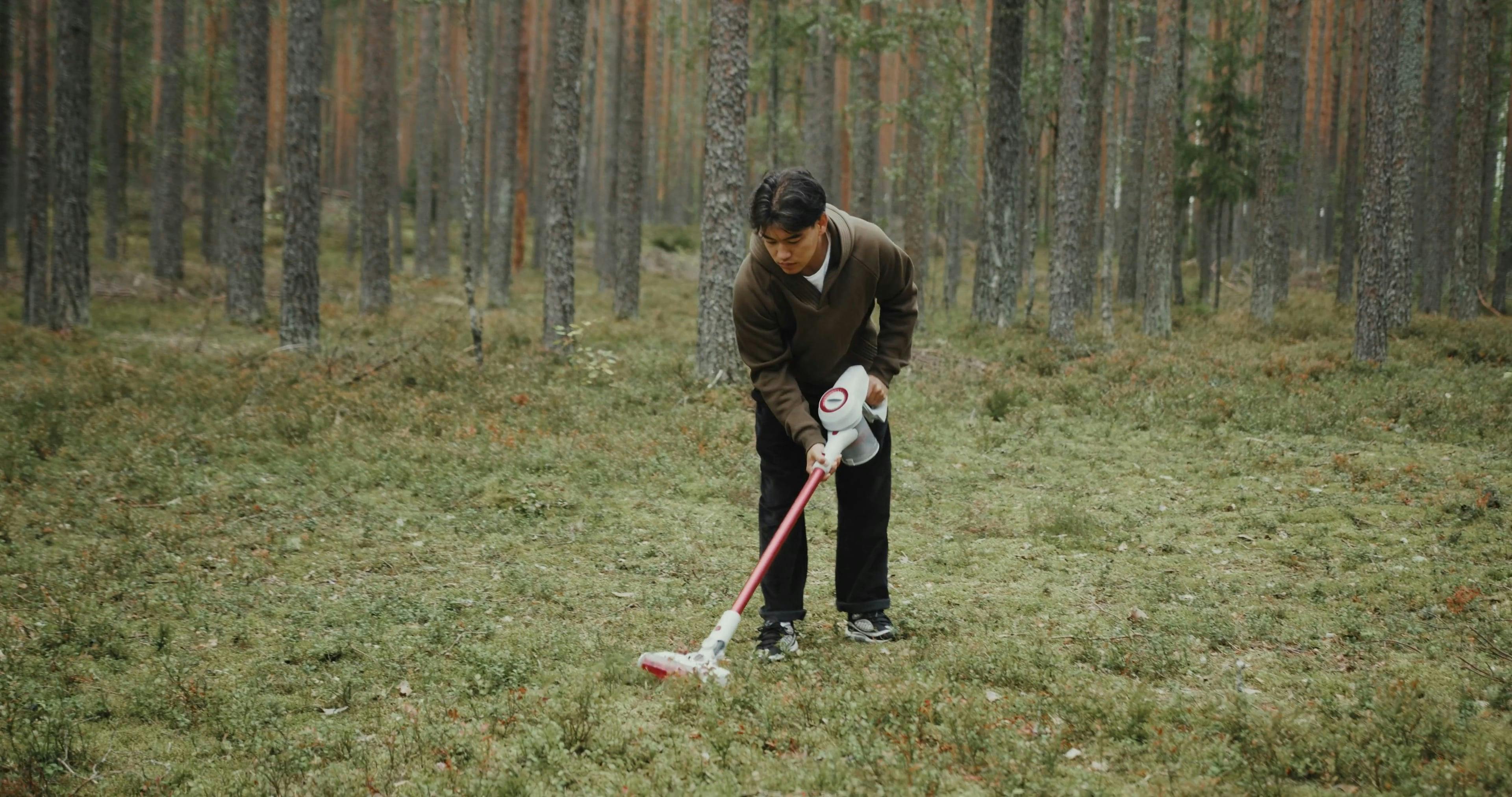 Man using Vacuum Cleaner in Forest · Free Stock Video