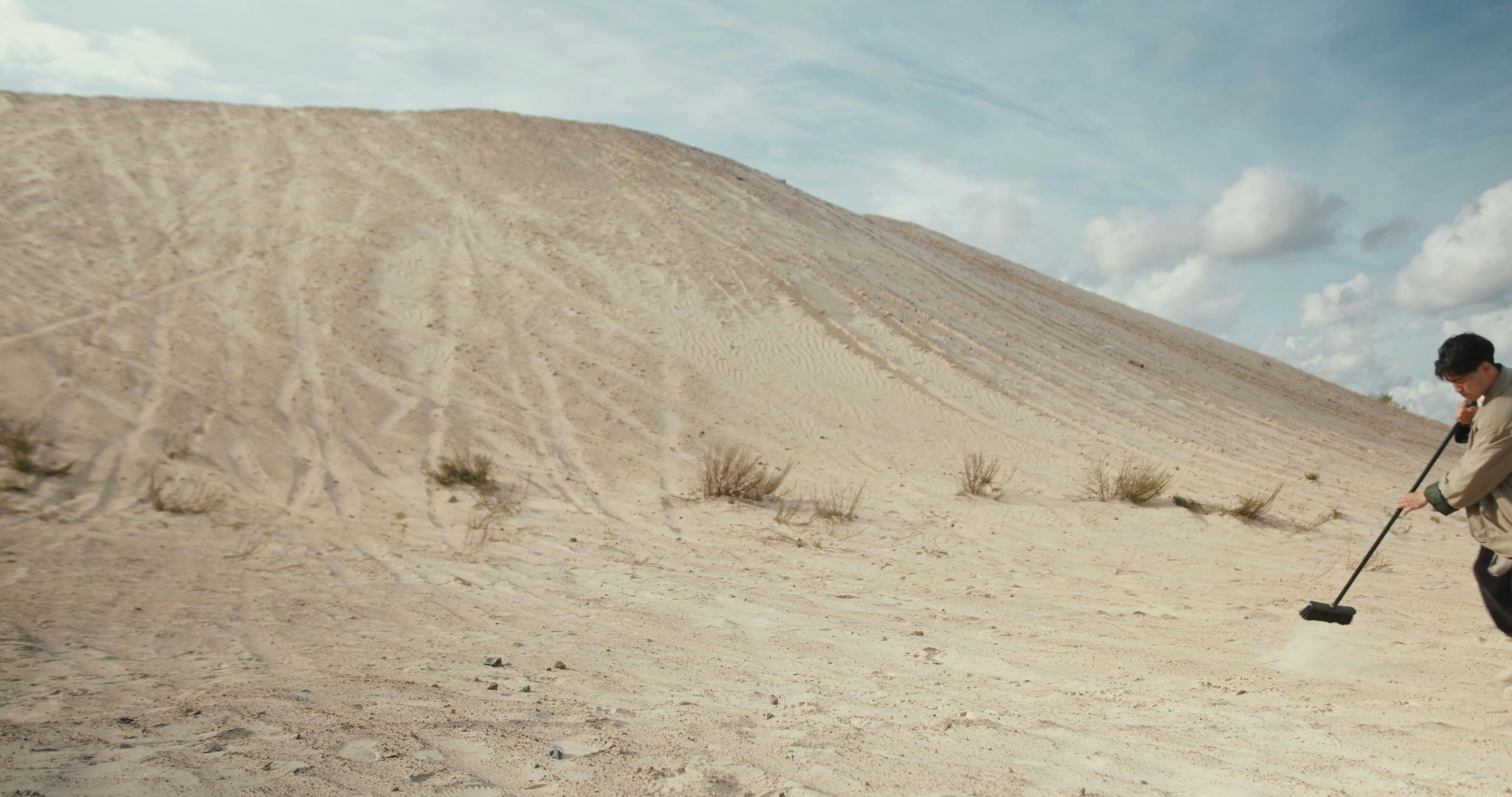 Man Sweeping Sand on a Desert Free Stock Video Footage, Royalty-Free 4K ...