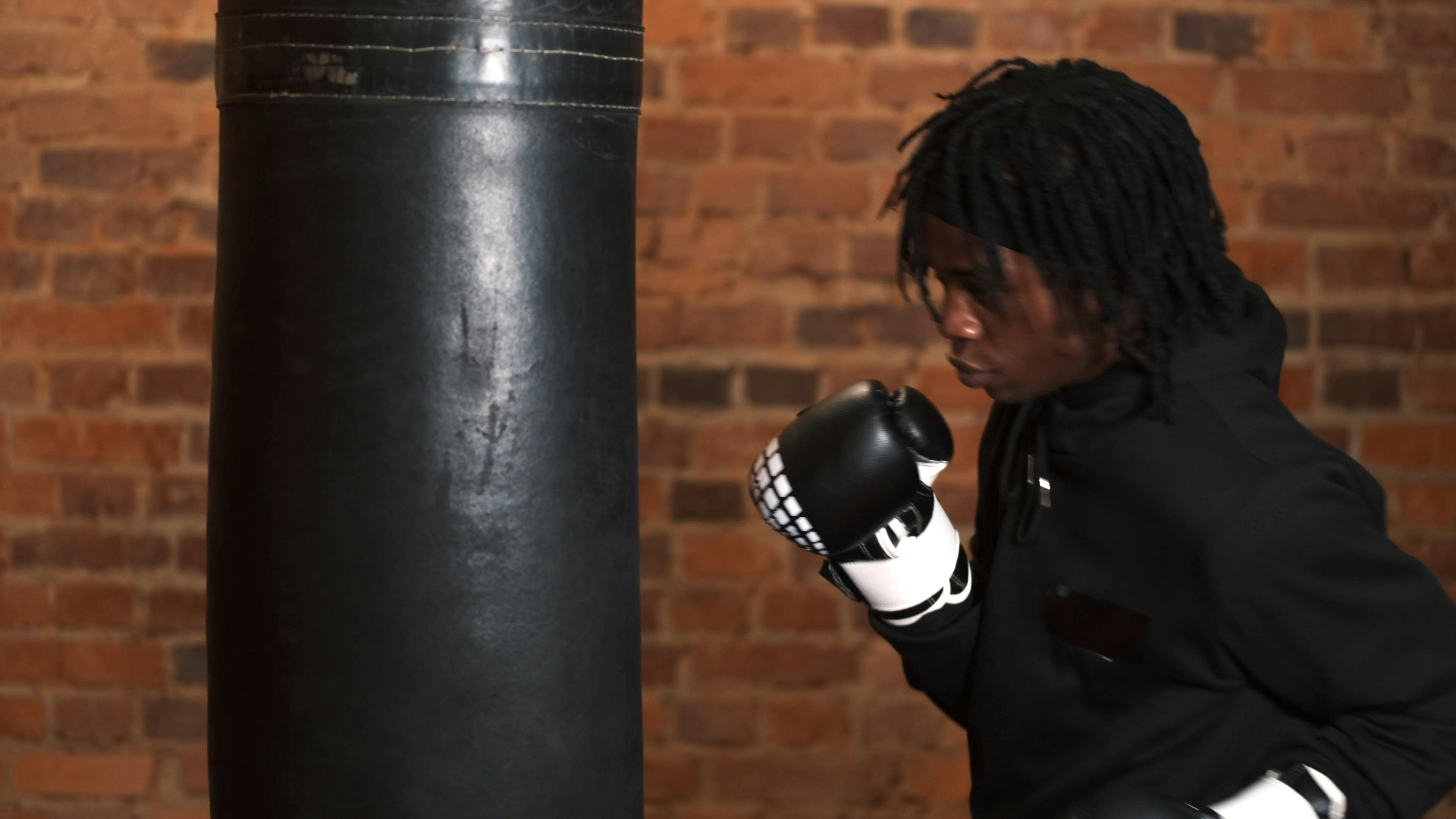 A Boxer Hitting A Punching Bag In Training · Free Stock Video