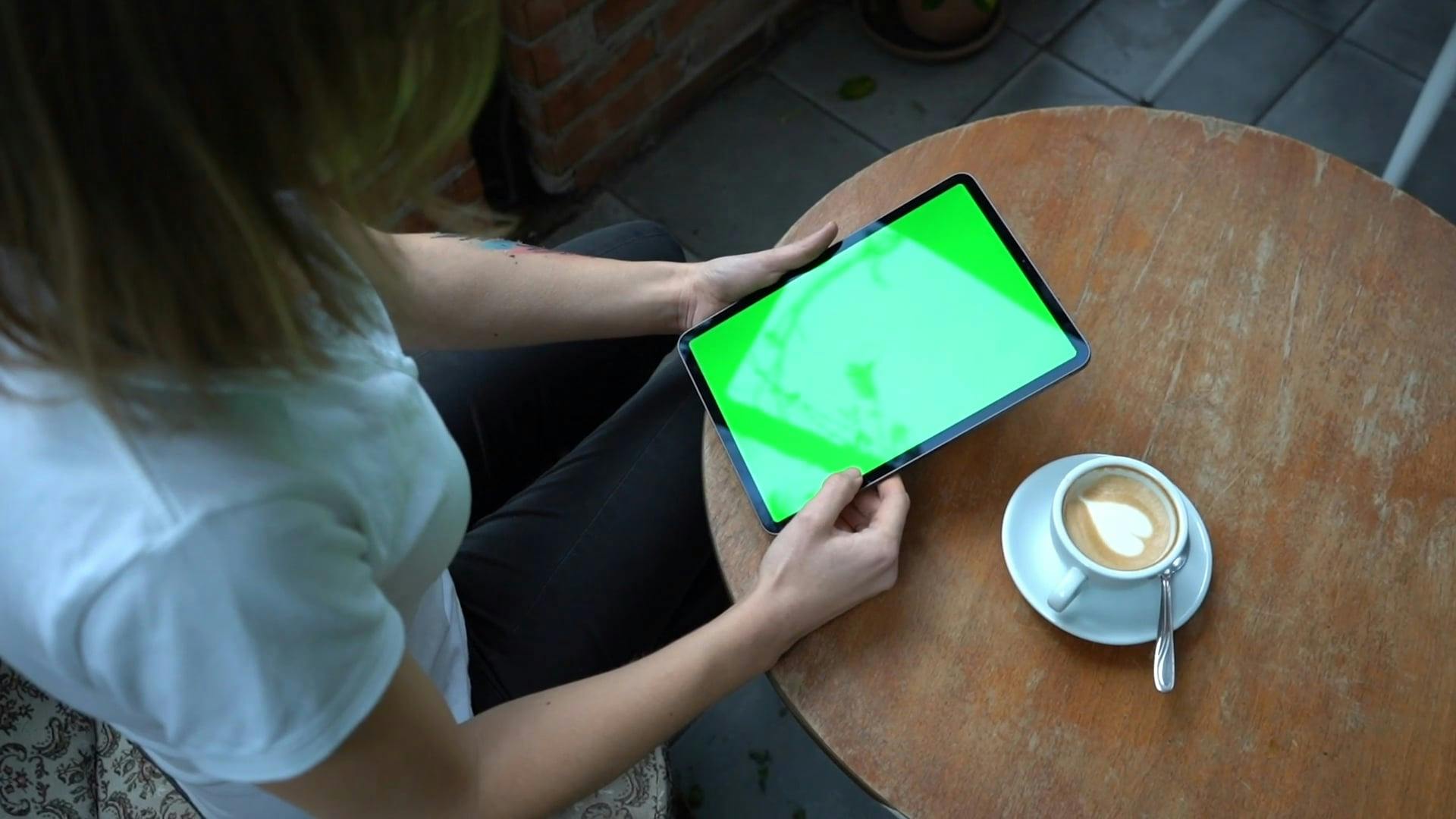A Woman Holding an iPad with a Coffee on the side Free Stock Video ...
