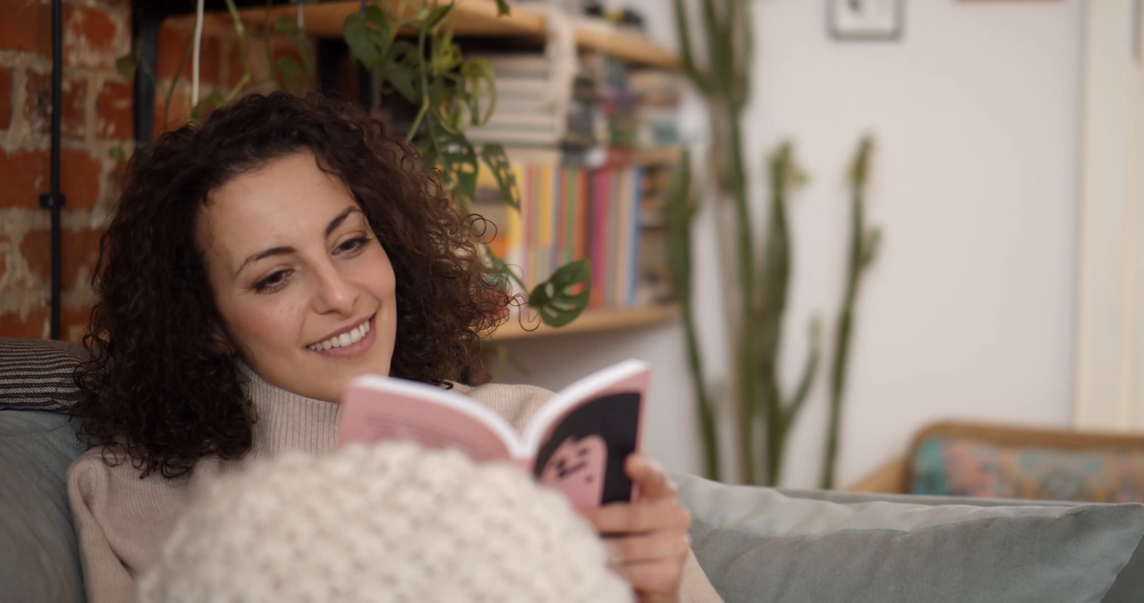 A Woman Laughing While Reading a Book Free Stock Video Footage, Royalty ...