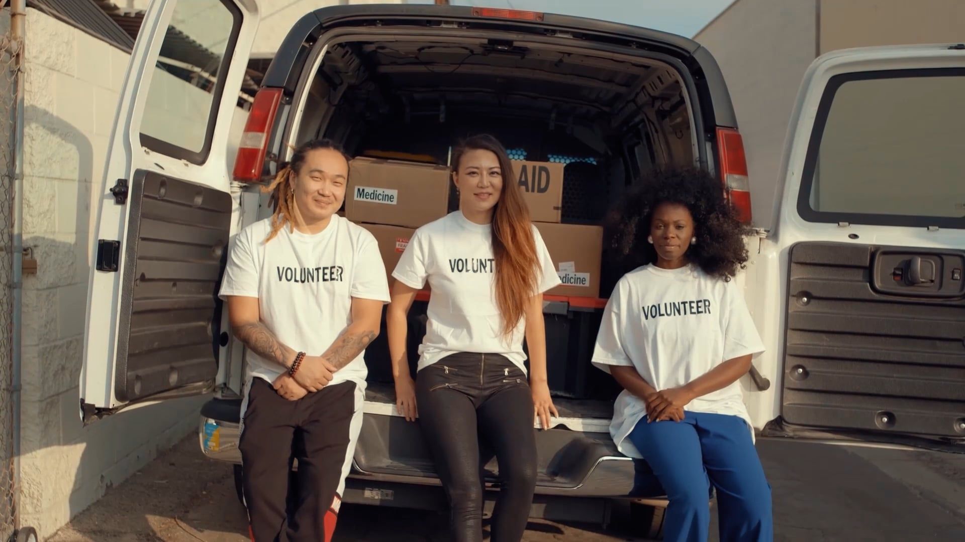 Volunteers Sitting on the Back of a Parked Van Free Stock Video Footage ...