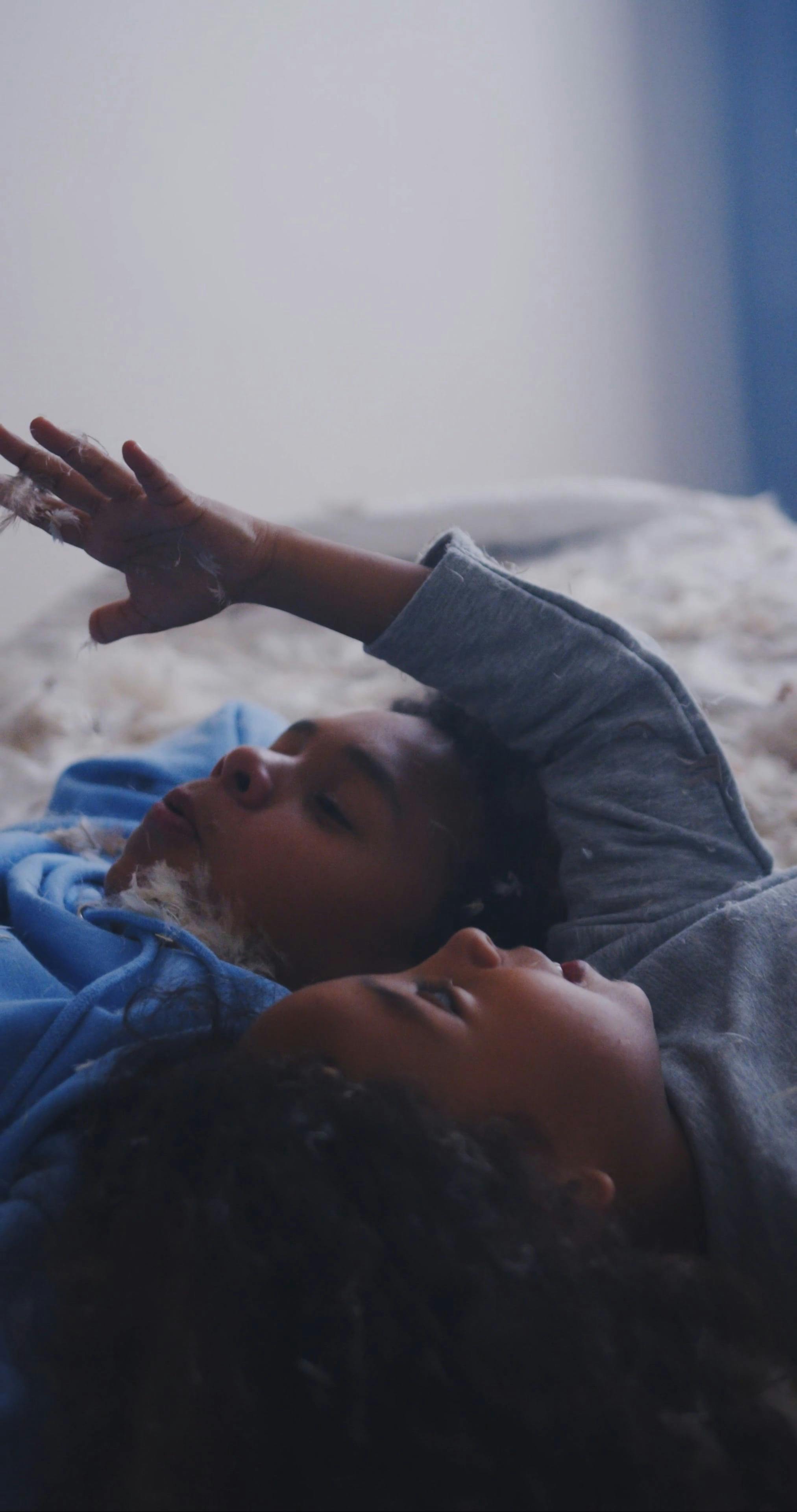 A Girl Throwing Feathers on Her Brother's Face · Free Stock Video