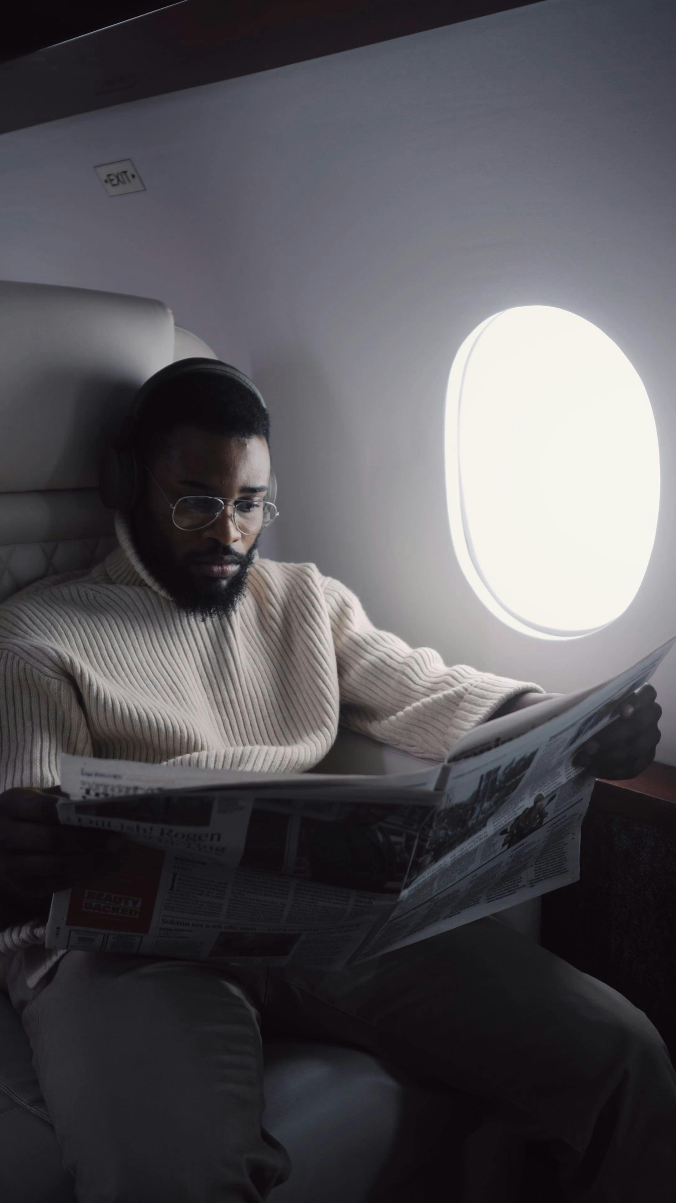 Reading Newspaper Next to the Plane Window Free Stock Video Footage ...