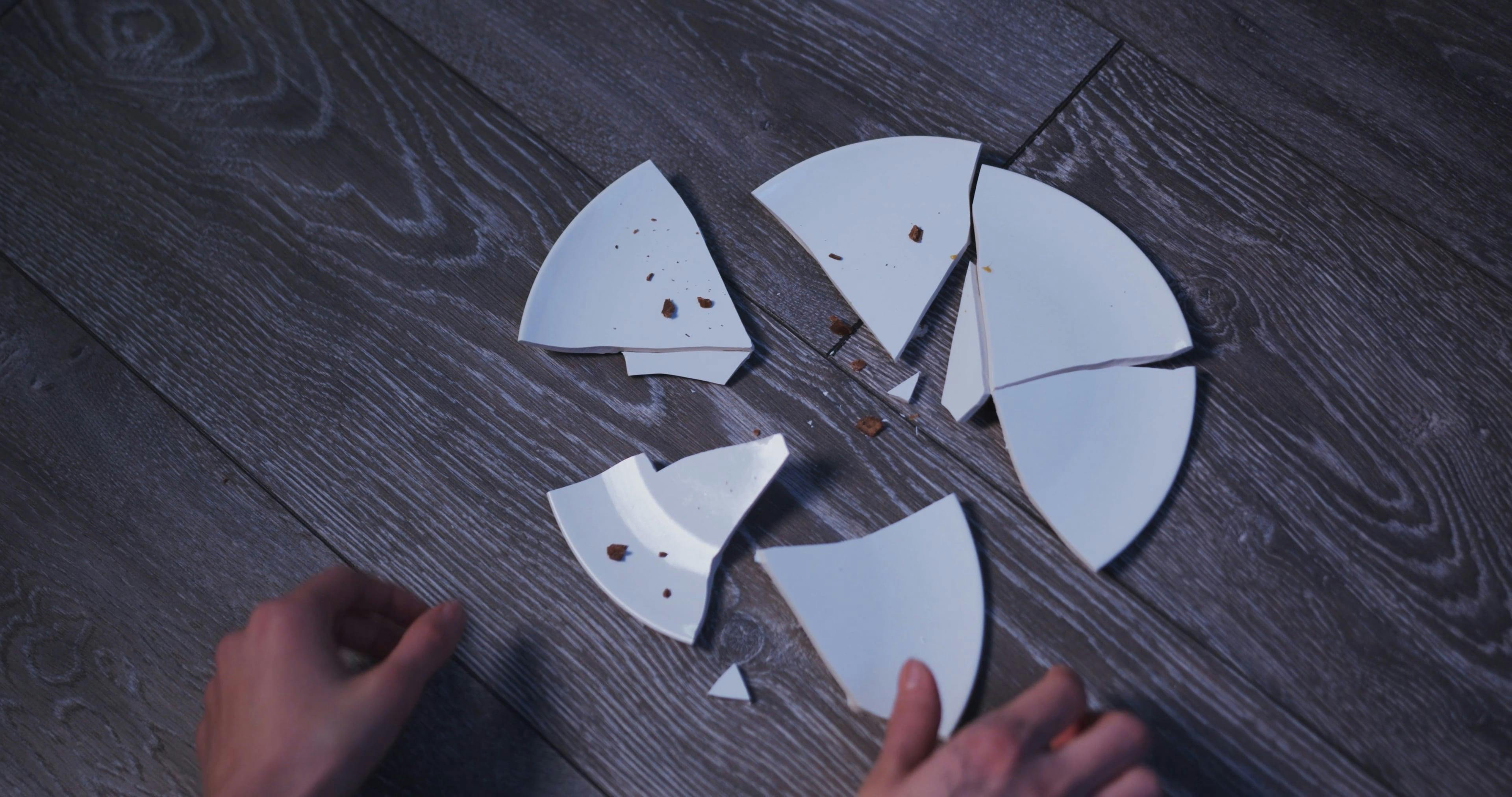 Person Picking Up a Broken Pieces of the Plate · Free Stock Video