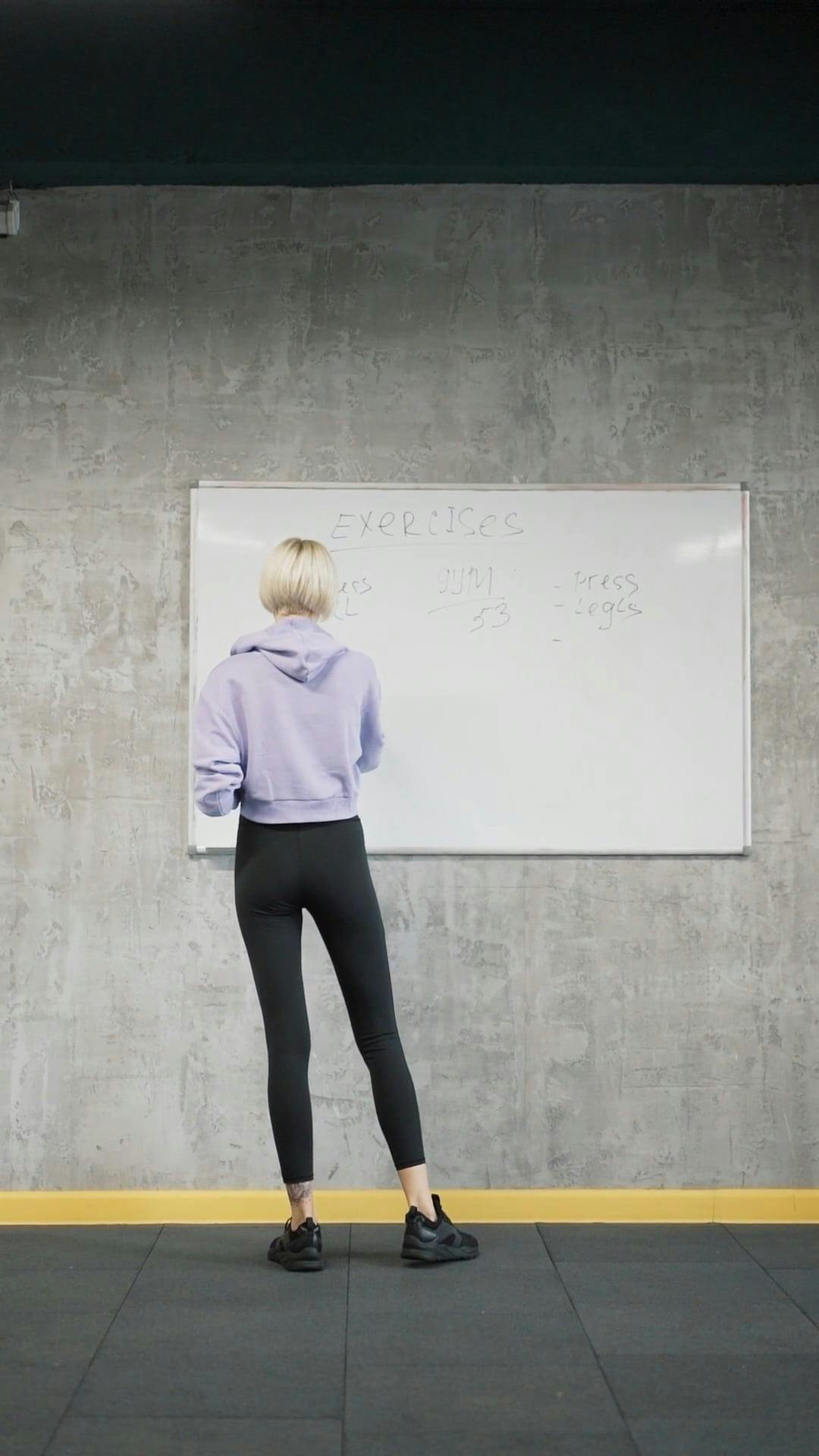 A Woman Writing Exercise Pilates On The Whiteboard Free Stock Video ...