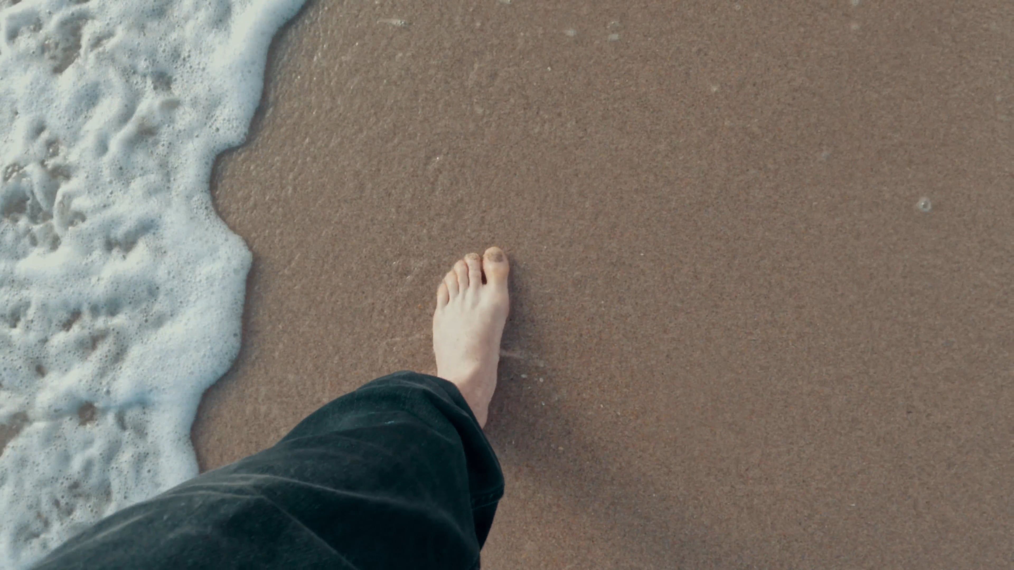 Person Walking on Seashore · Free Stock Video