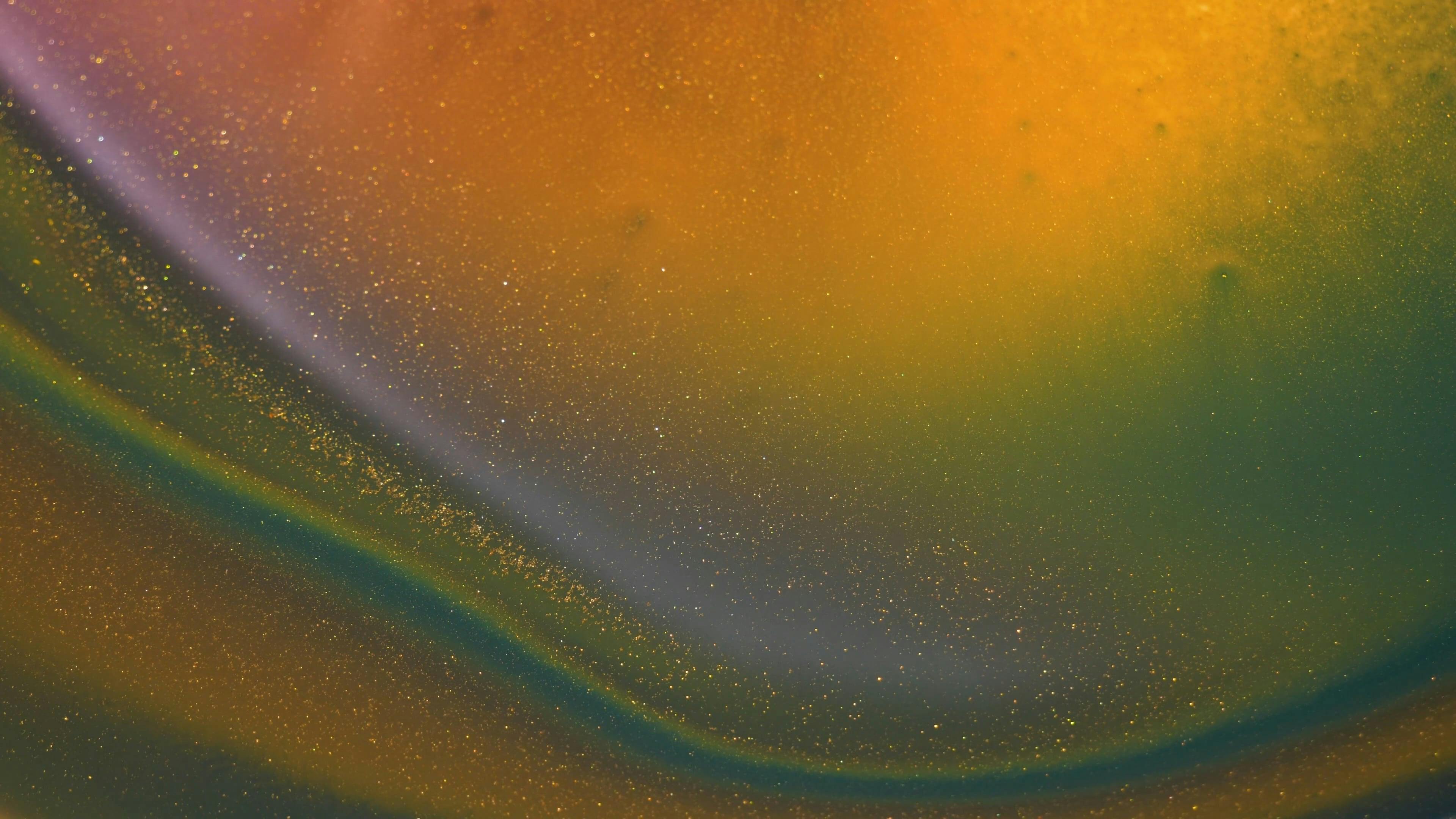 Glitter Particles Floating in Colorful Liquid · Free Stock Video