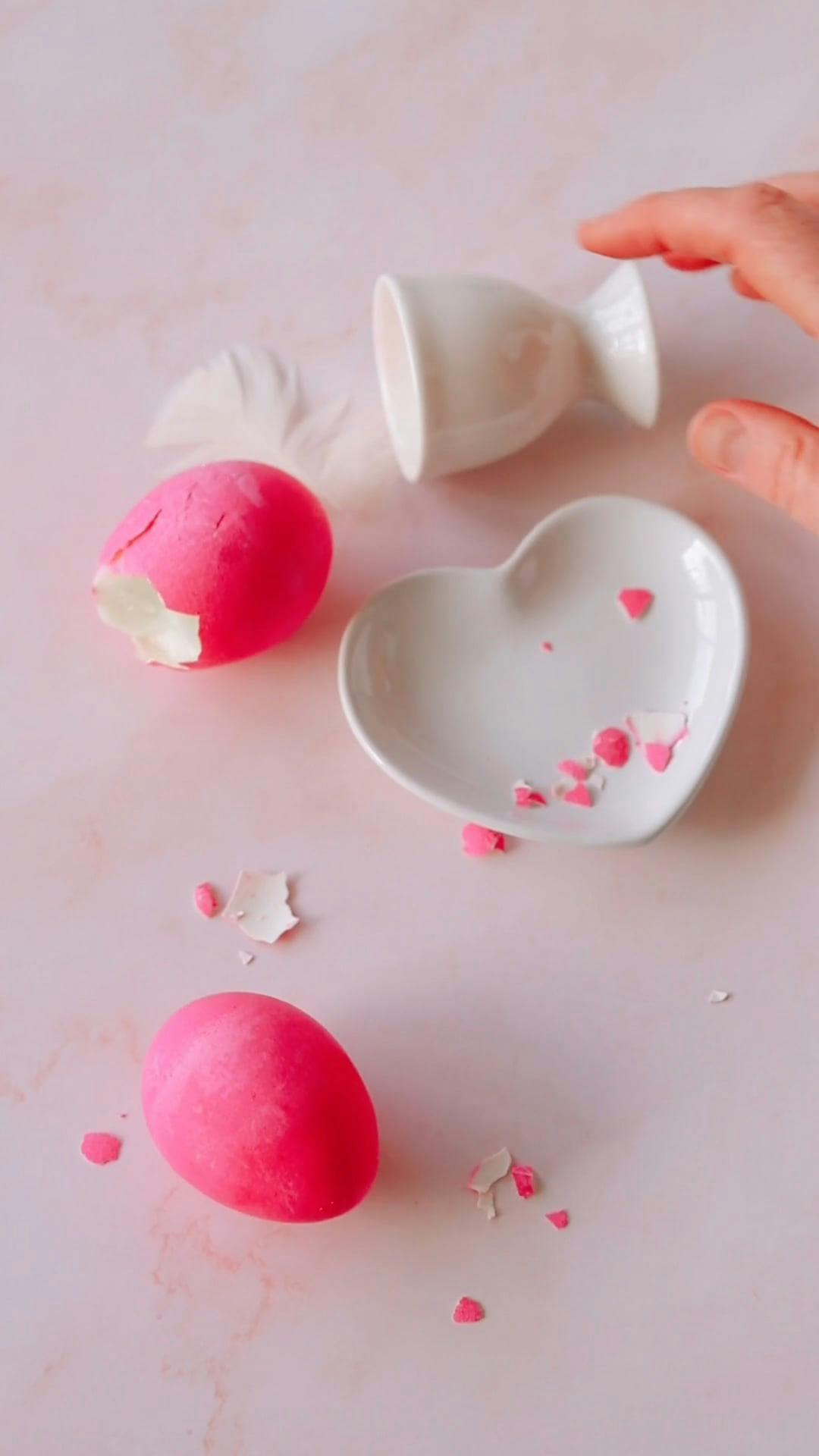 A Person Putting a Pink Hard Boiled Egg on a Stand Free Stock Video ...