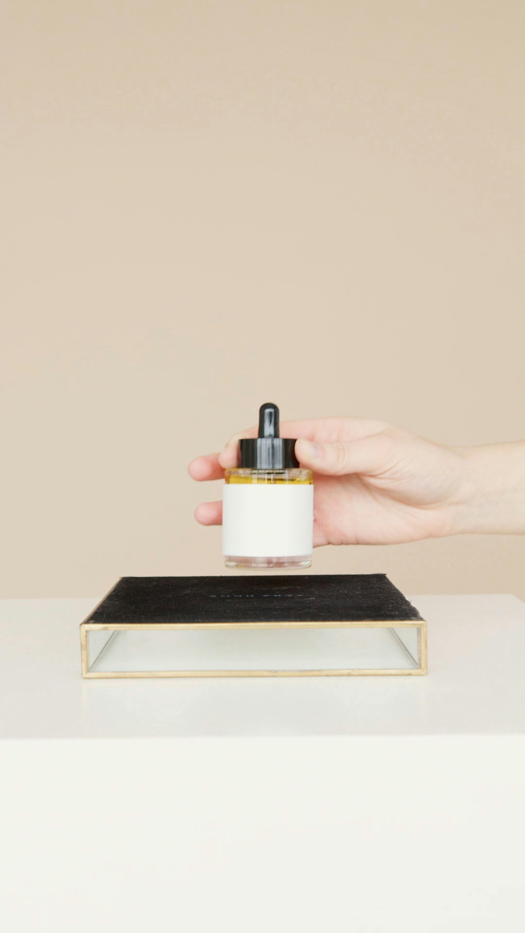 Person Placing Dropper Bottle on a Table Free Stock Video Footage ...