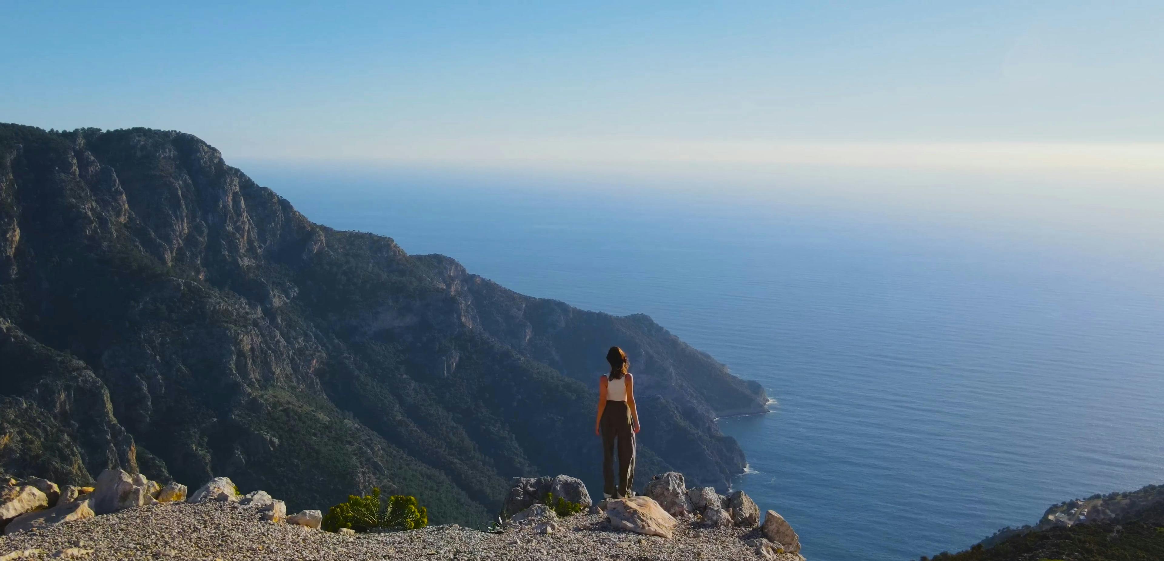Woman Standing on Cliff Edge · Free Stock Video