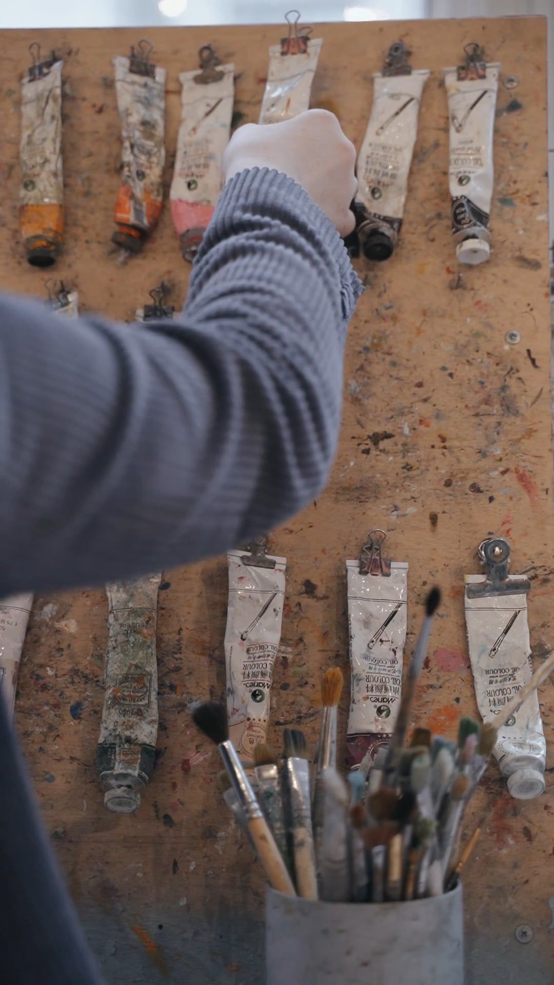 A Person Hanging a Tube of Paint · Free Stock Video