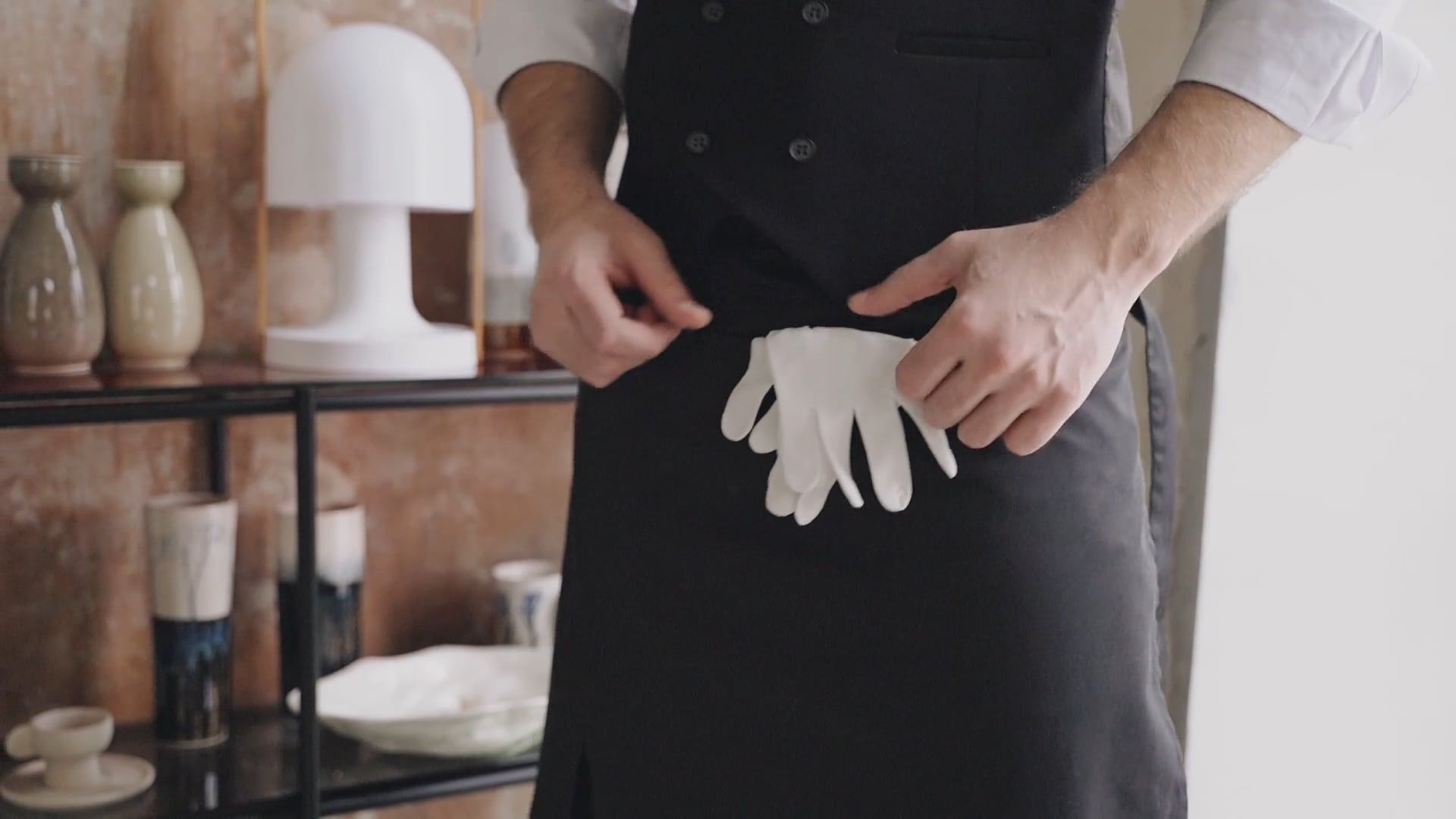 Man Fixing the Gloves that are Hanging from His Apron Free Stock Video ...
