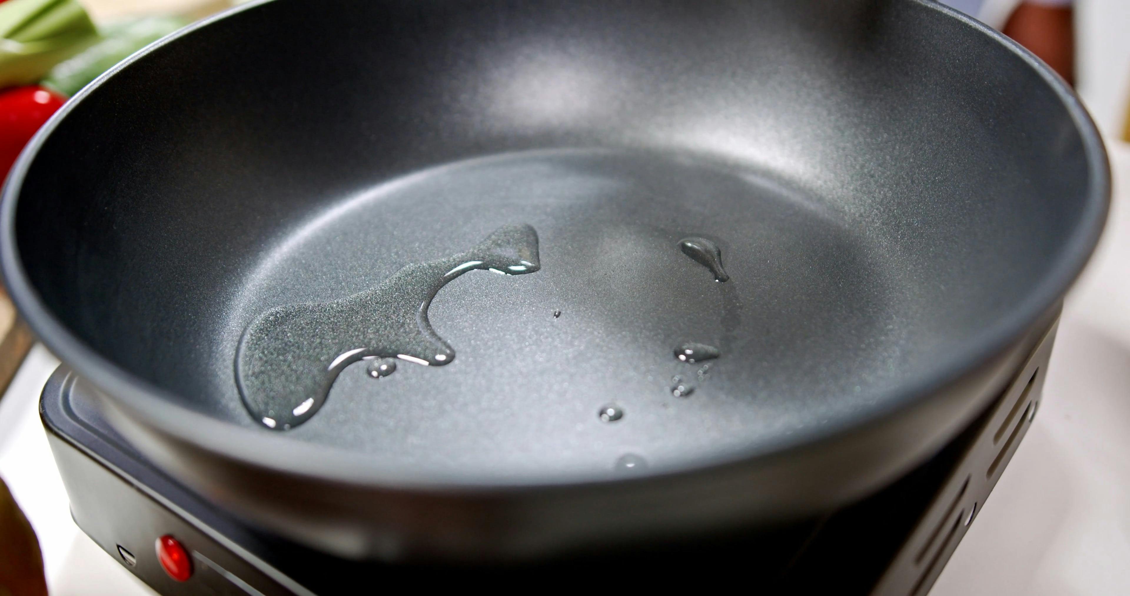 Person Pouring Oil In Frying Pan · Free Stock Video
