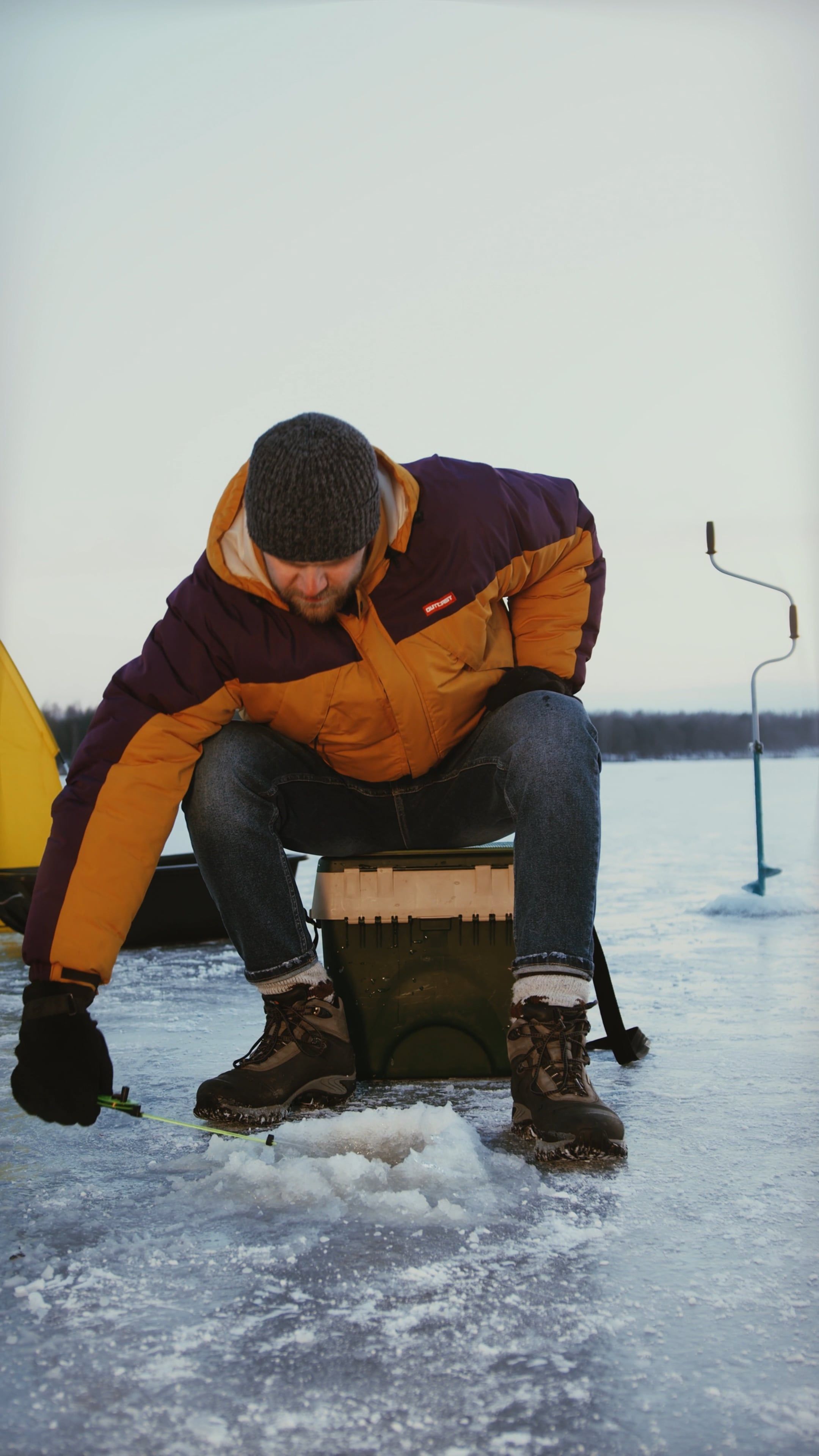 A Man Drinking Coffee While Ice Fishing · Free Stock Video