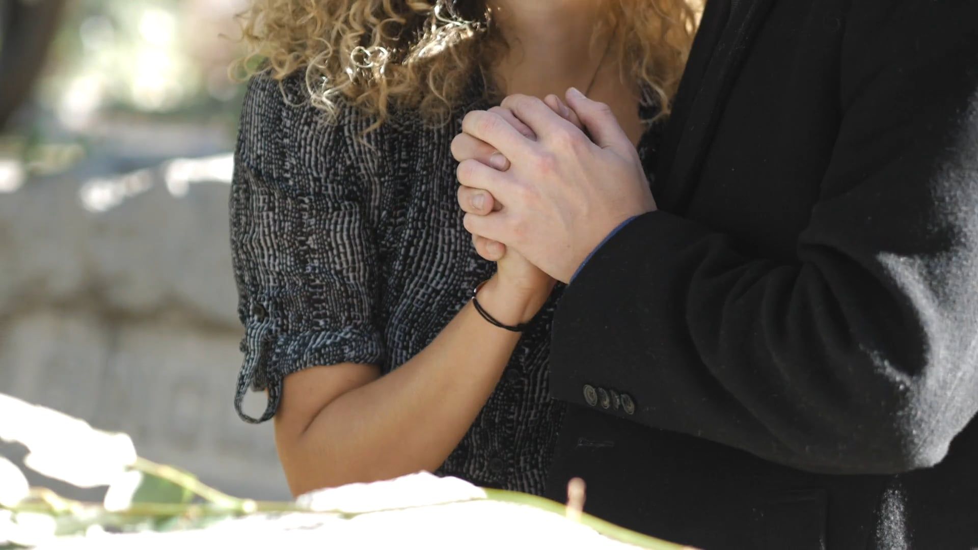 A Man Comforting a Crying Woman in the Cemetery · Free Stock Video