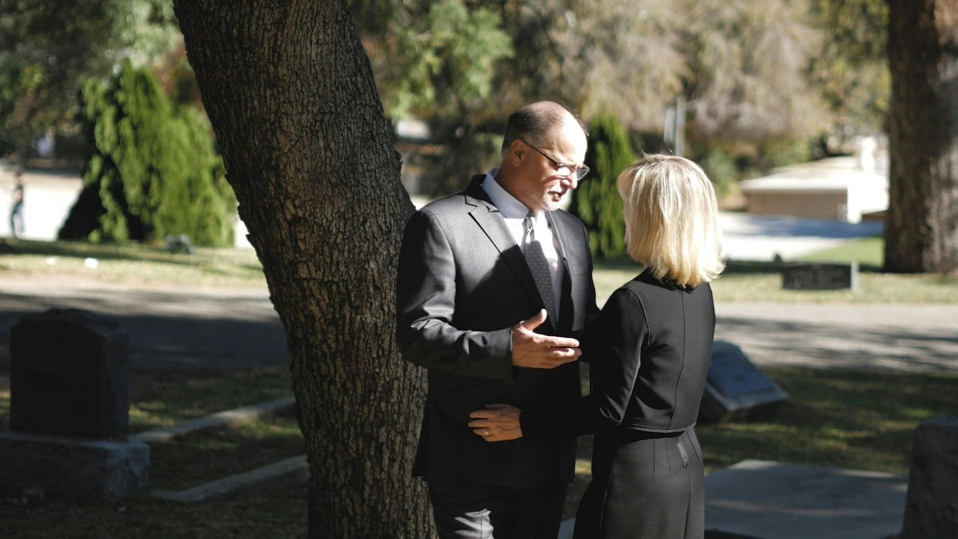Man Hugging a Woman at a Cemetery · Free Stock Video