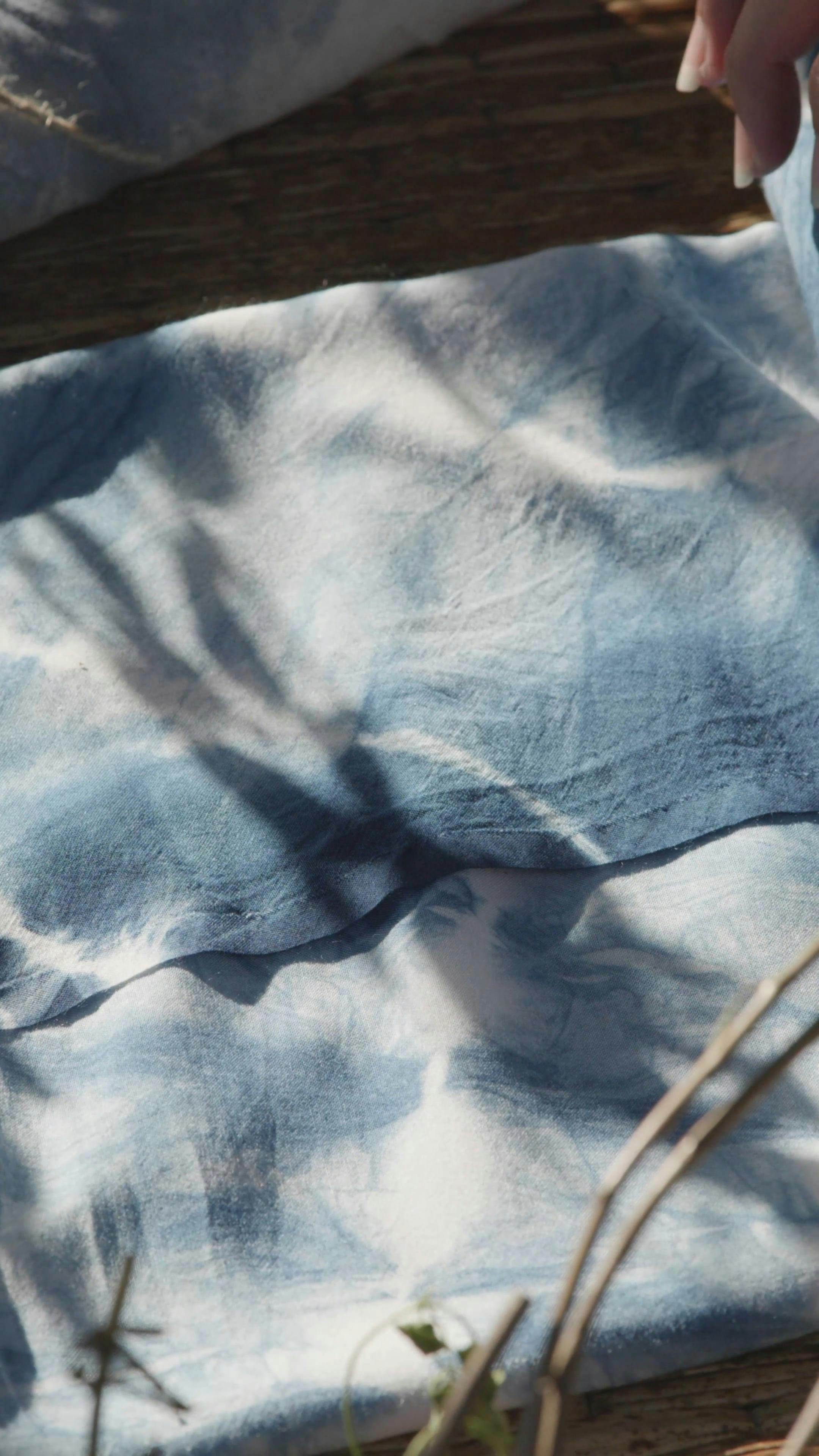 A Person Rolling a Piece of Cloth · Free Stock Video