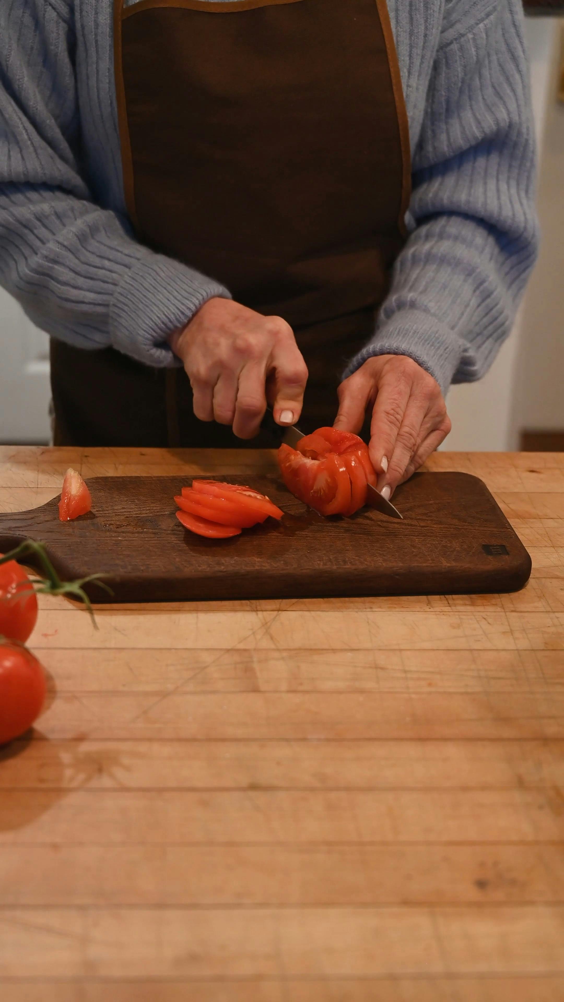 Person Slicing Fresh Tomato · Free Stock Video