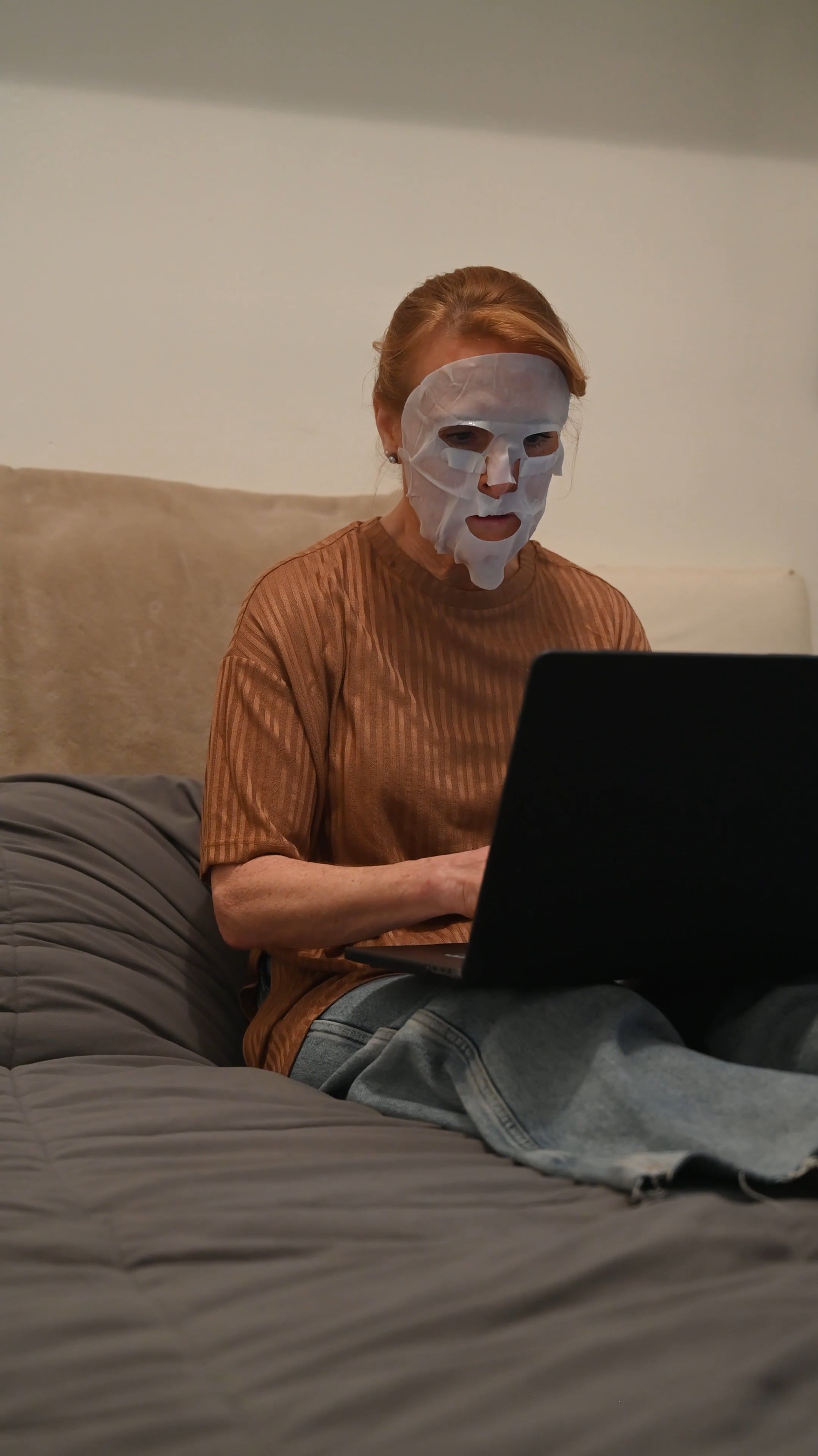 A Woman Using a Laptop while Wearing a Facial Mask · Free Stock Video
