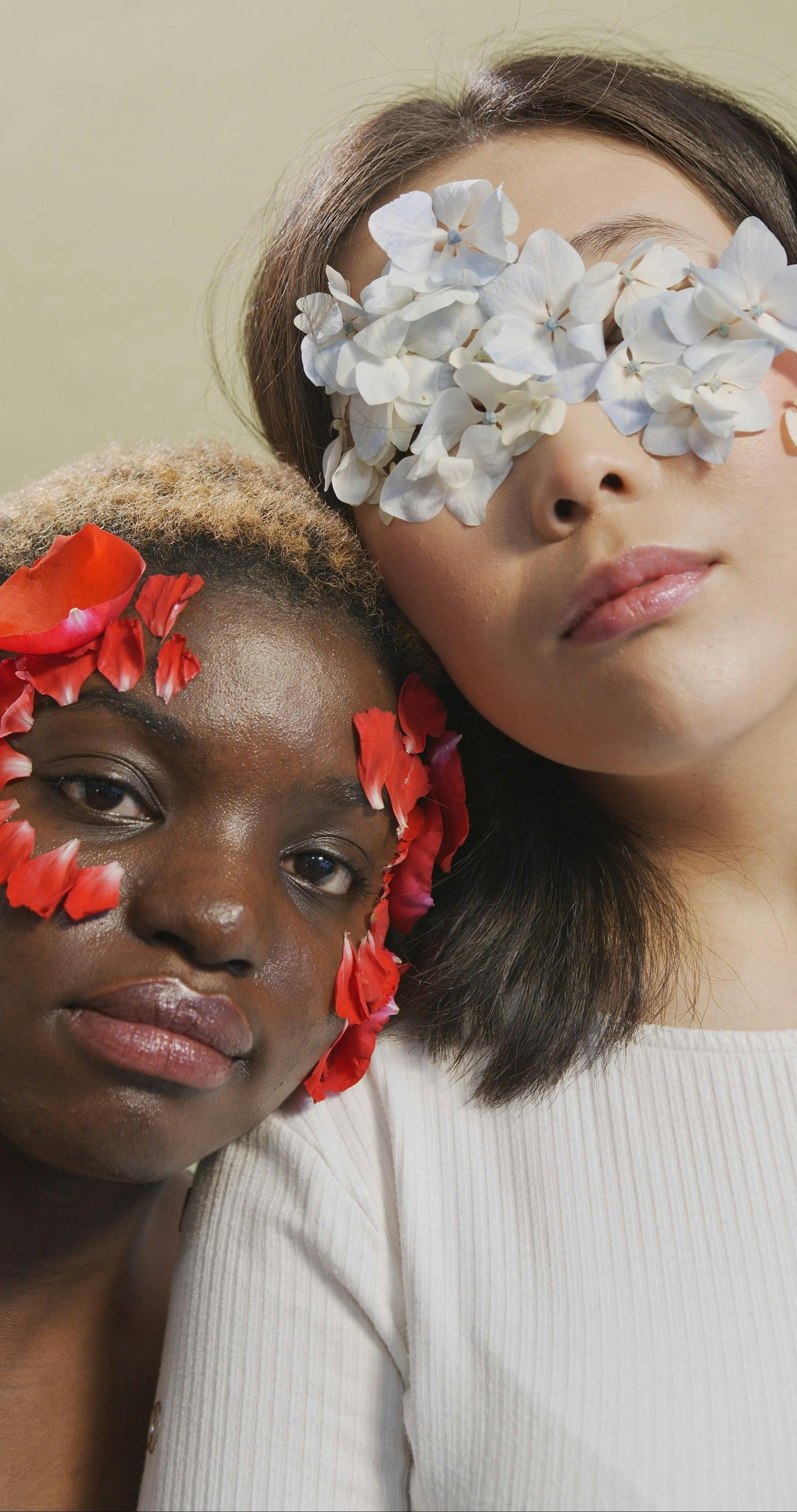 Women With Petals on Their Faces Looking at Camera Free Stock Video ...