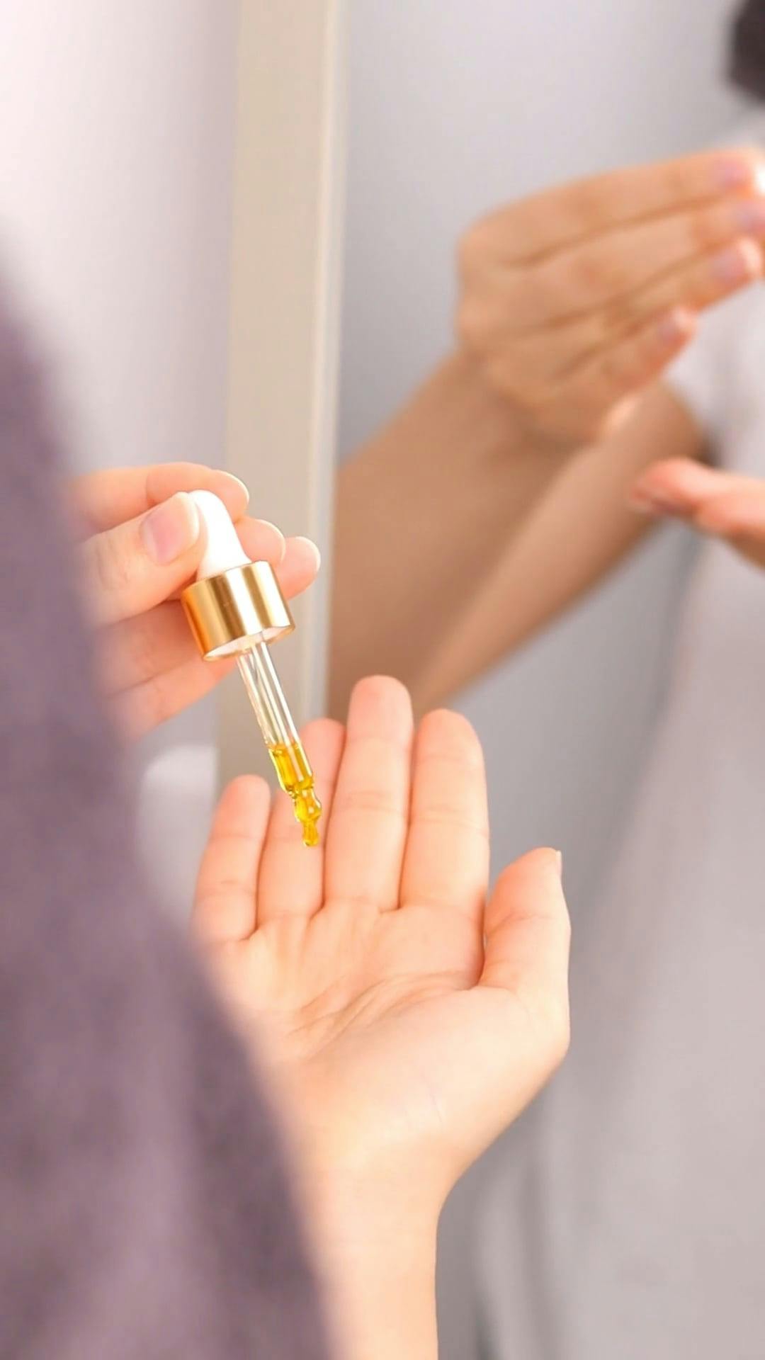 Person Applying Cosmetic Oil With a Dropper · Free Stock Video