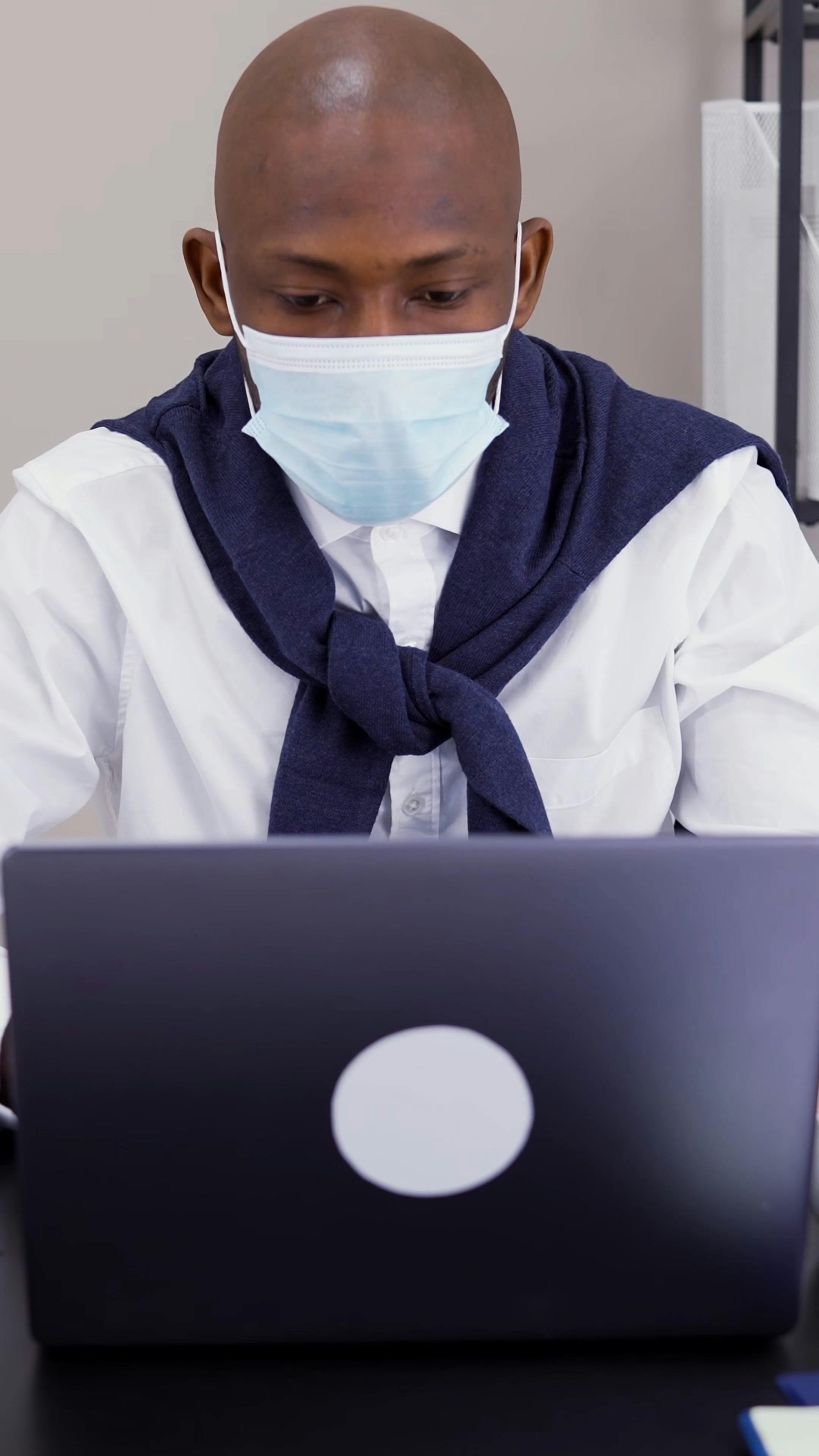 Man Wearing Face Mask While Using a Laptop · Free Stock Video