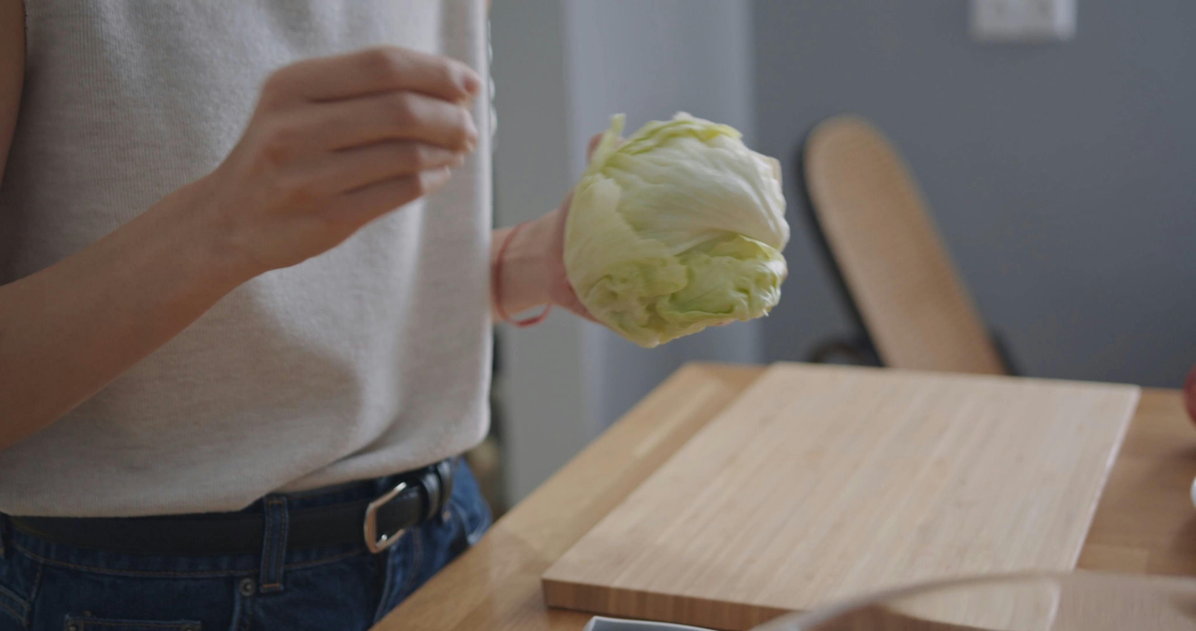 A Woman Putting Cabbage on a Bowl Free Stock Video Footage, Royalty ...