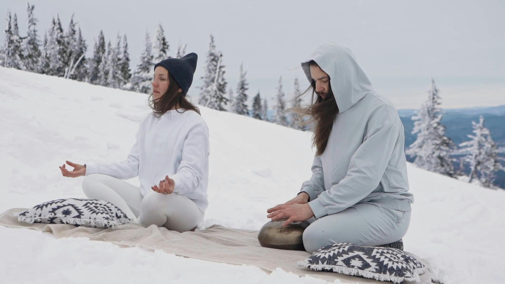 A Man and a Woman Meditating and Praying in the Snow Covered Mountain ...