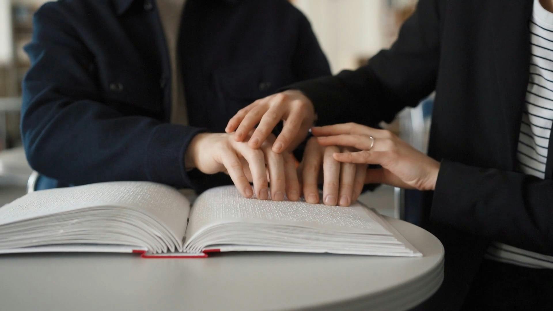 A Woman Guiding a Man in Reading Braille · Free Stock Video