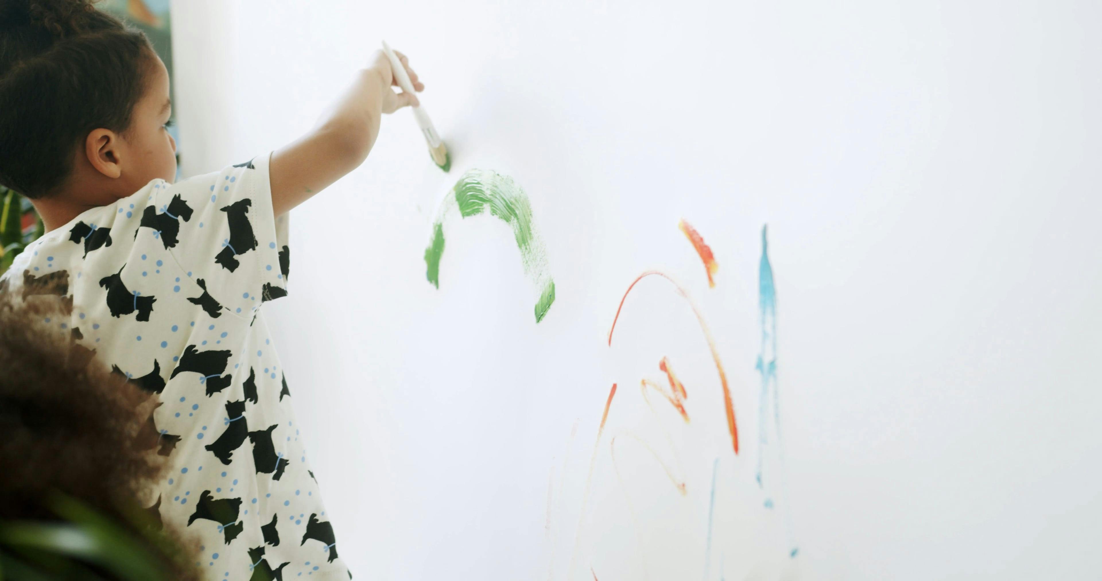 A Kid Drawing on Big Canvas · Free Stock Video