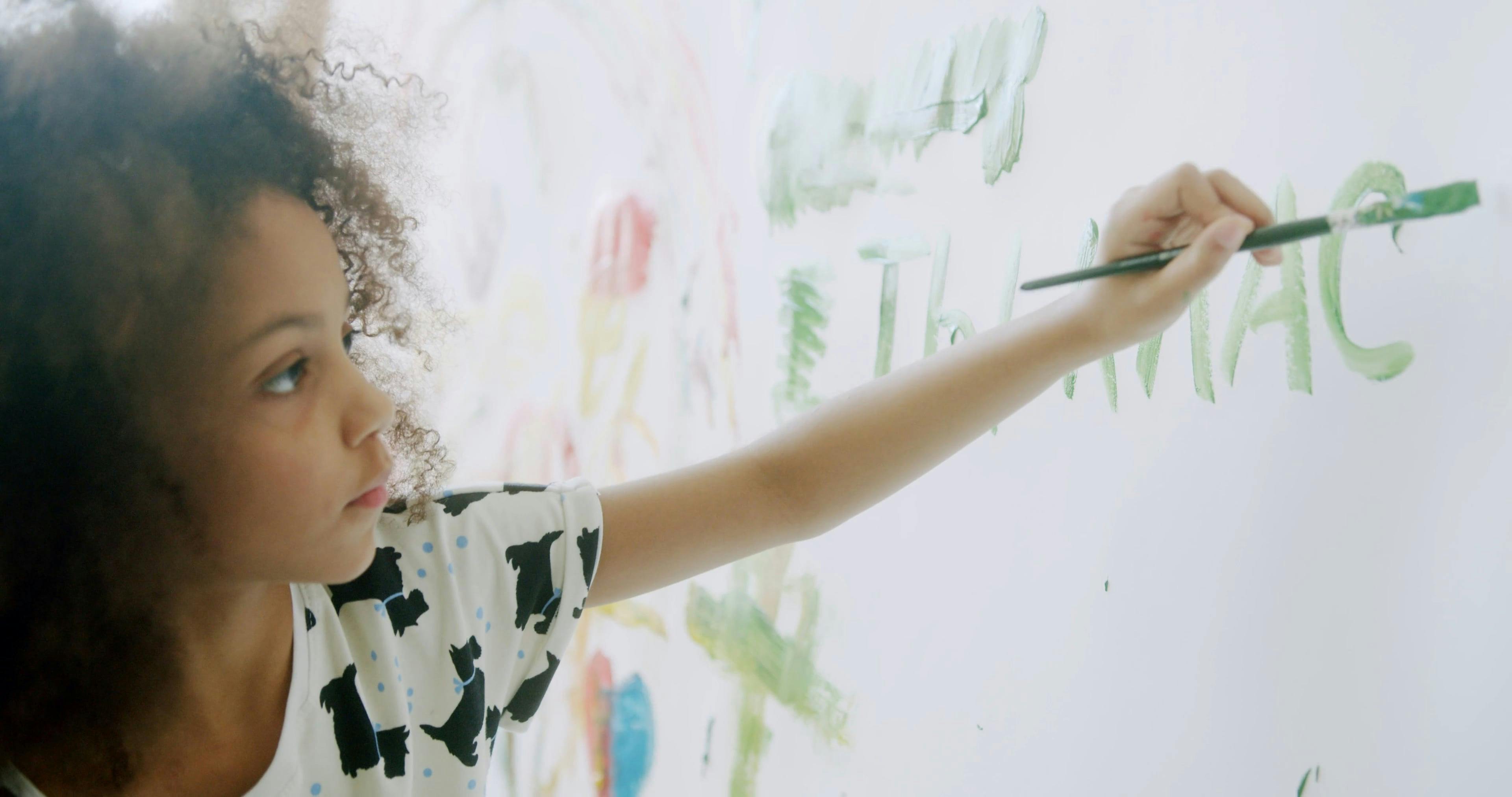 Girl Writing Using a Paintbrush · Free Stock Video